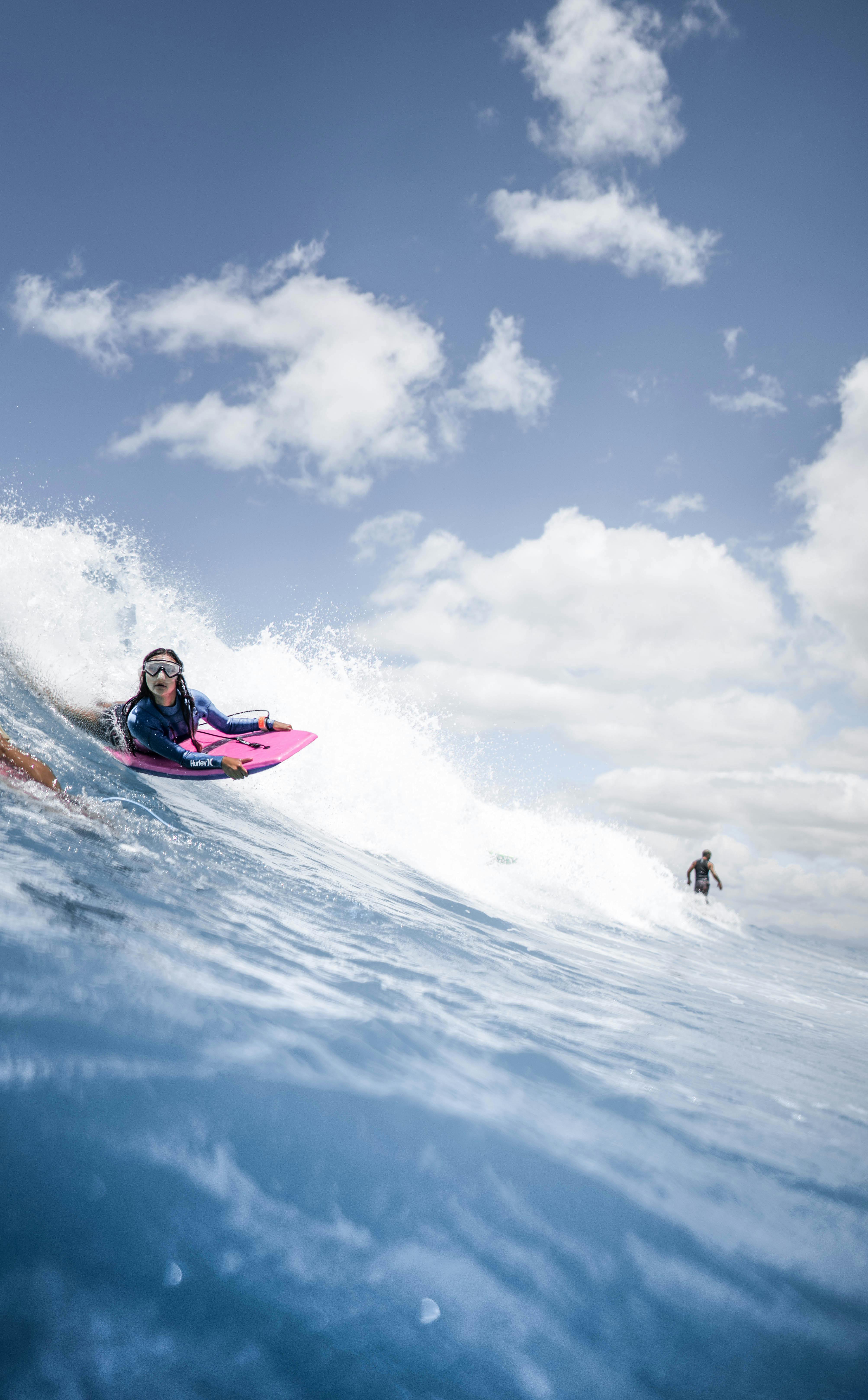 Photo Of People Surfing On The Ocean · Free Stock Photo