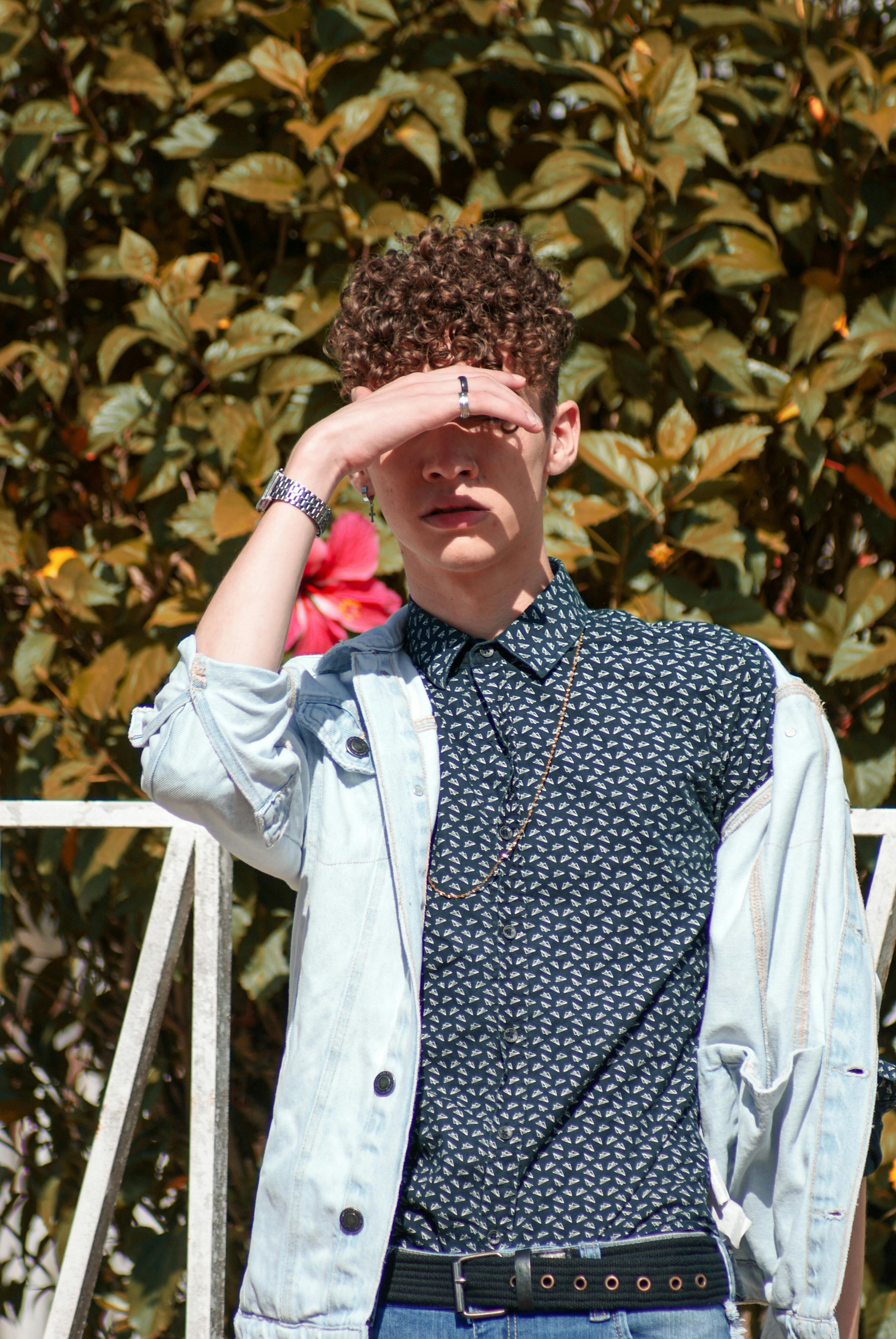 Stylish young man covering face from sun · Free Stock Photo