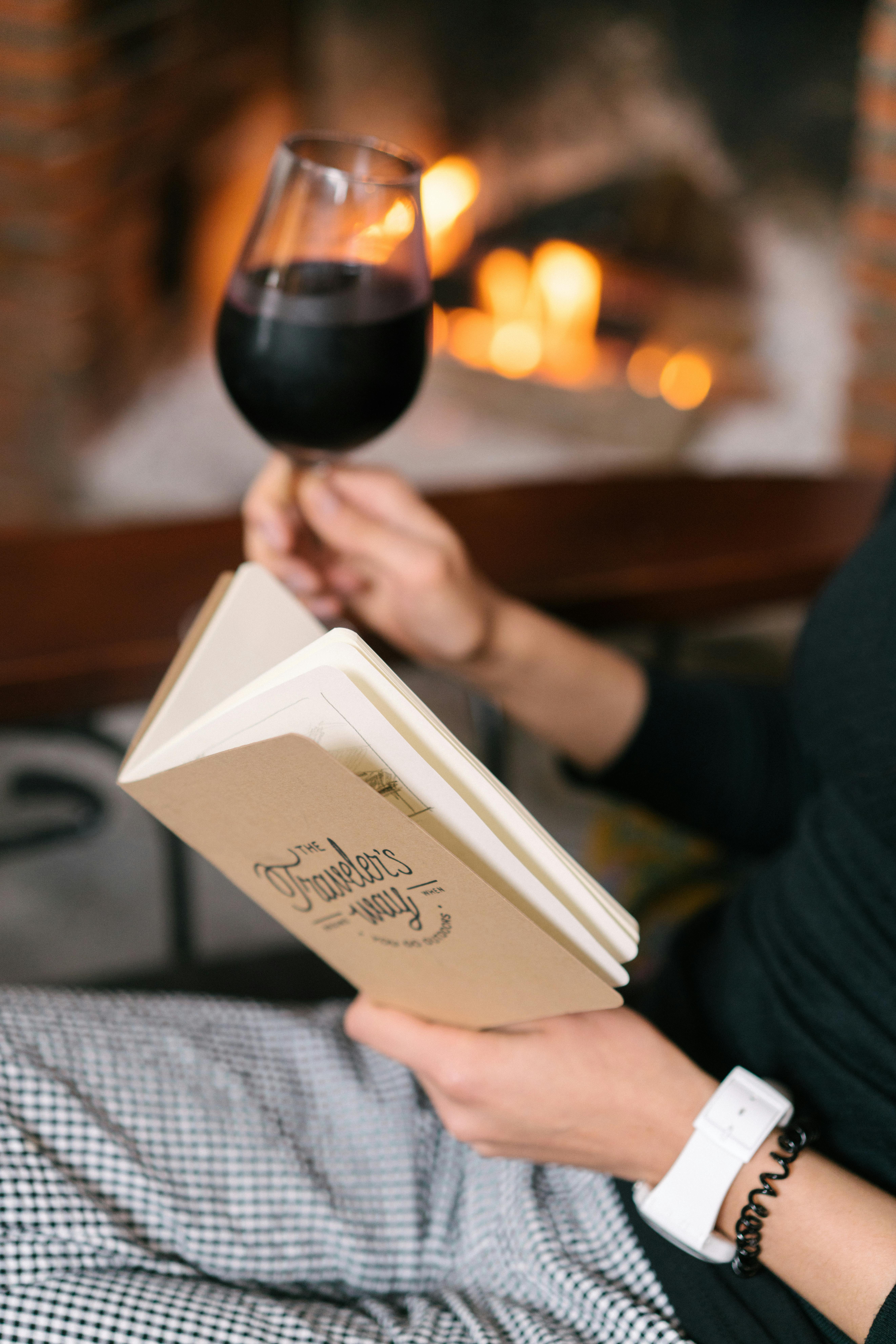 Woman Reading and Drinking Wine Near Fireplace · Free Stock Photo
