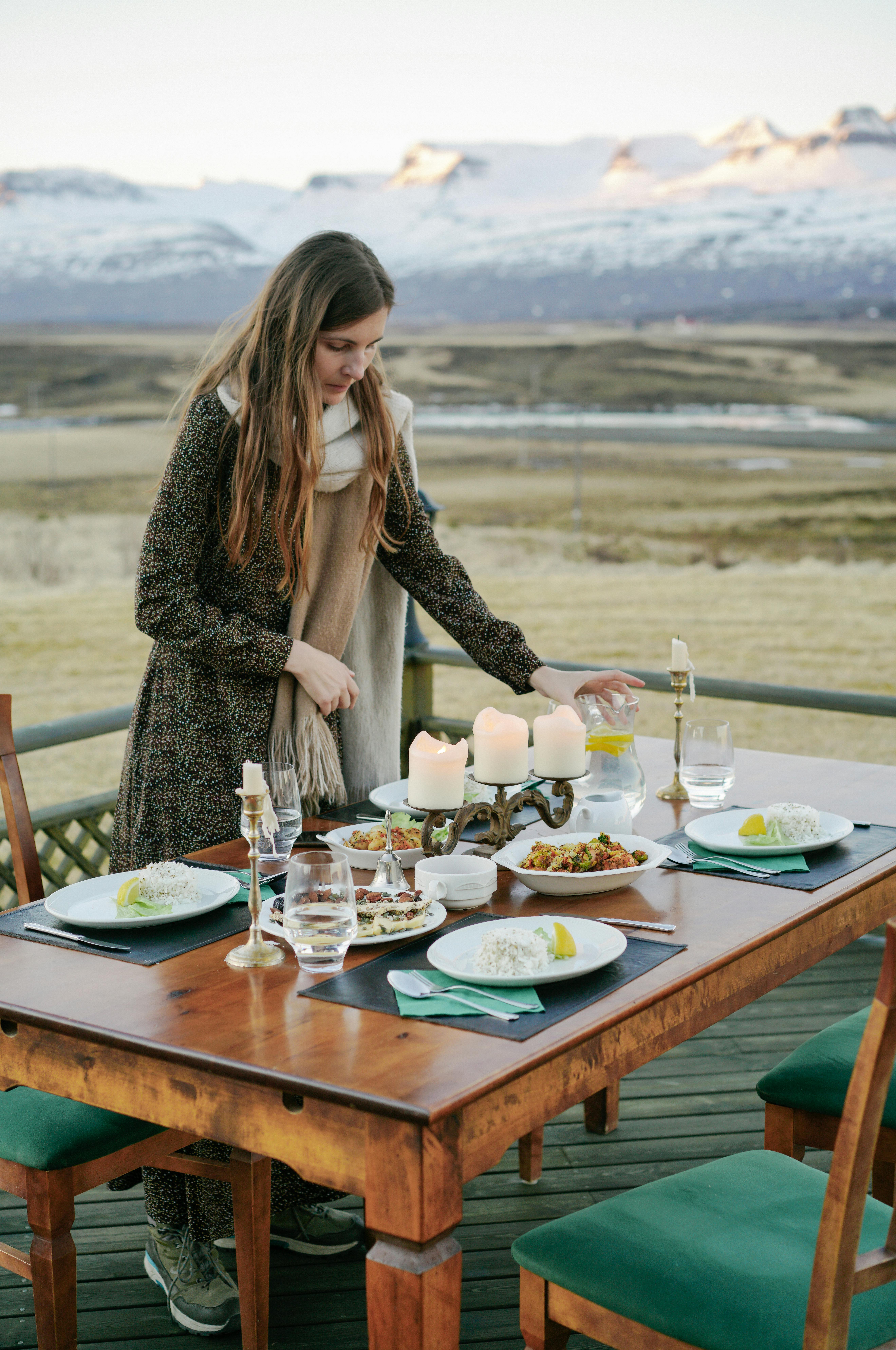 Woman Standing by Table with Food · Free Stock Photo
