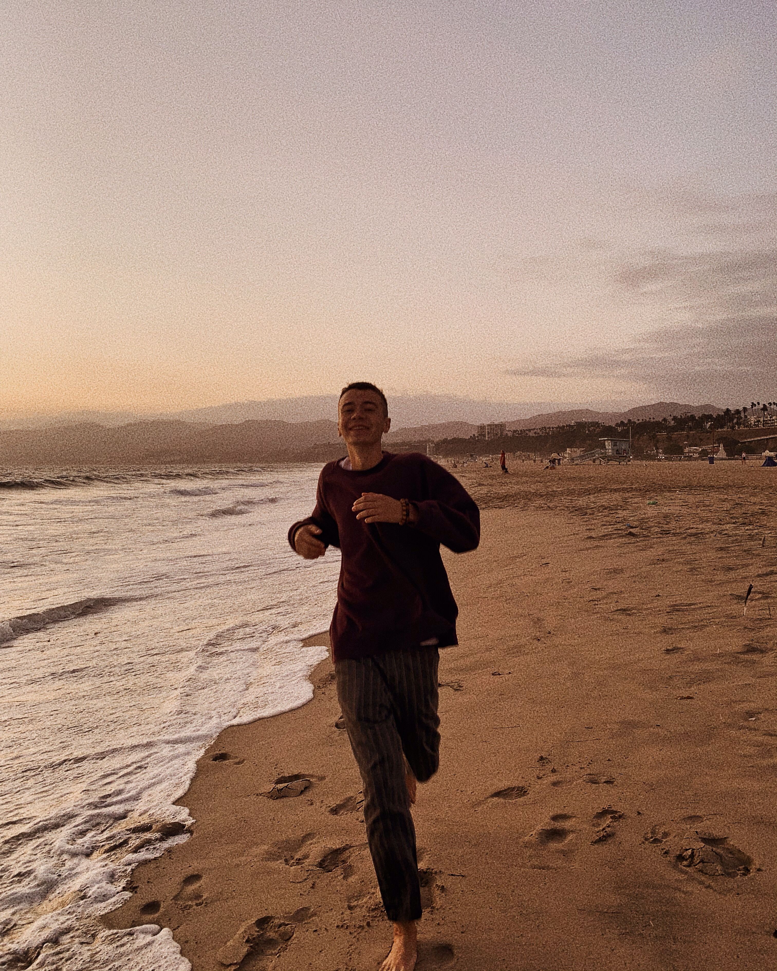 Happy man running on beach · Free Stock Photo