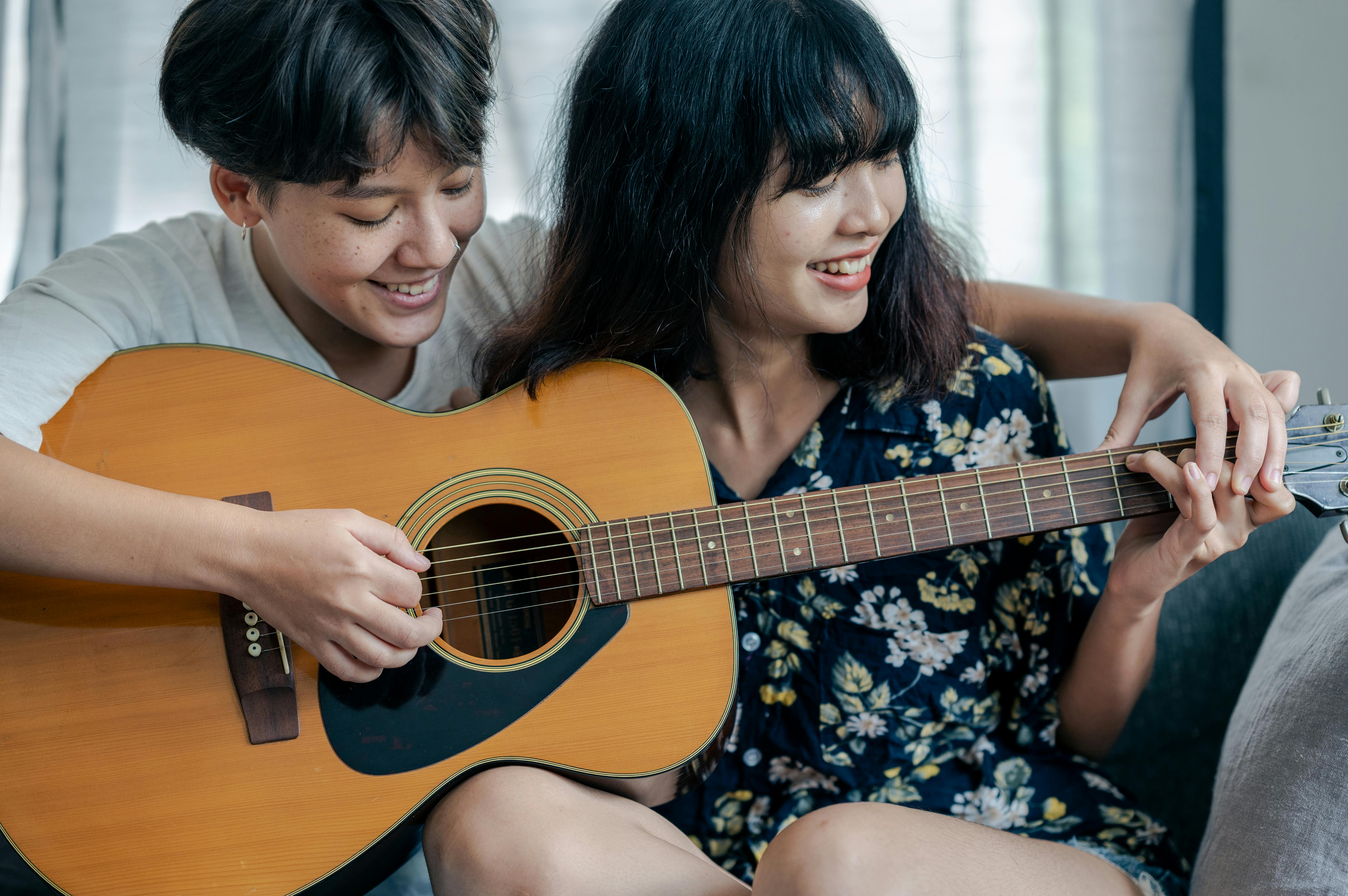 Women Playing Guitar Together · Free Stock Photo