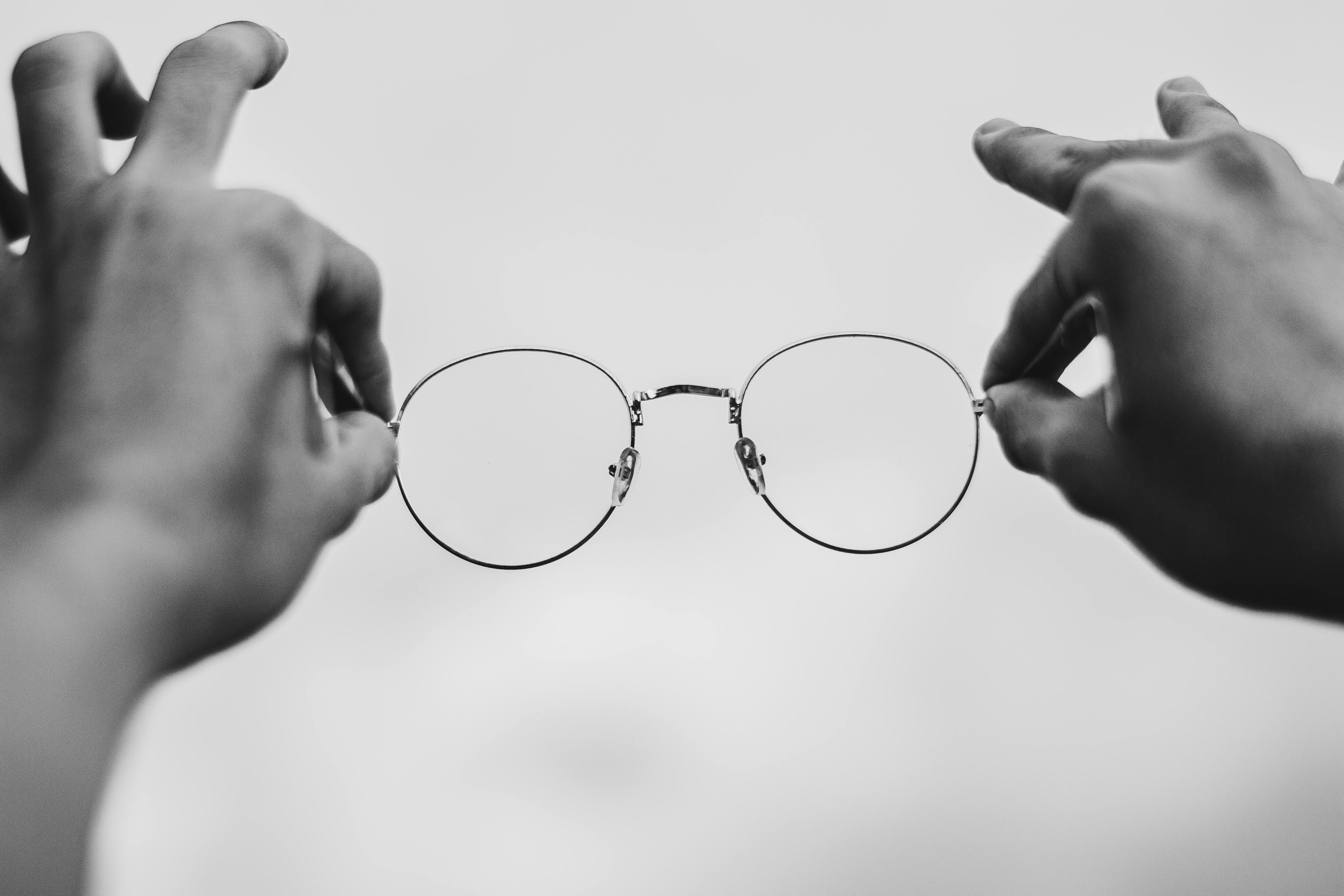 Person Holding Silver Framed Eyeglasses · Free Stock Photo
