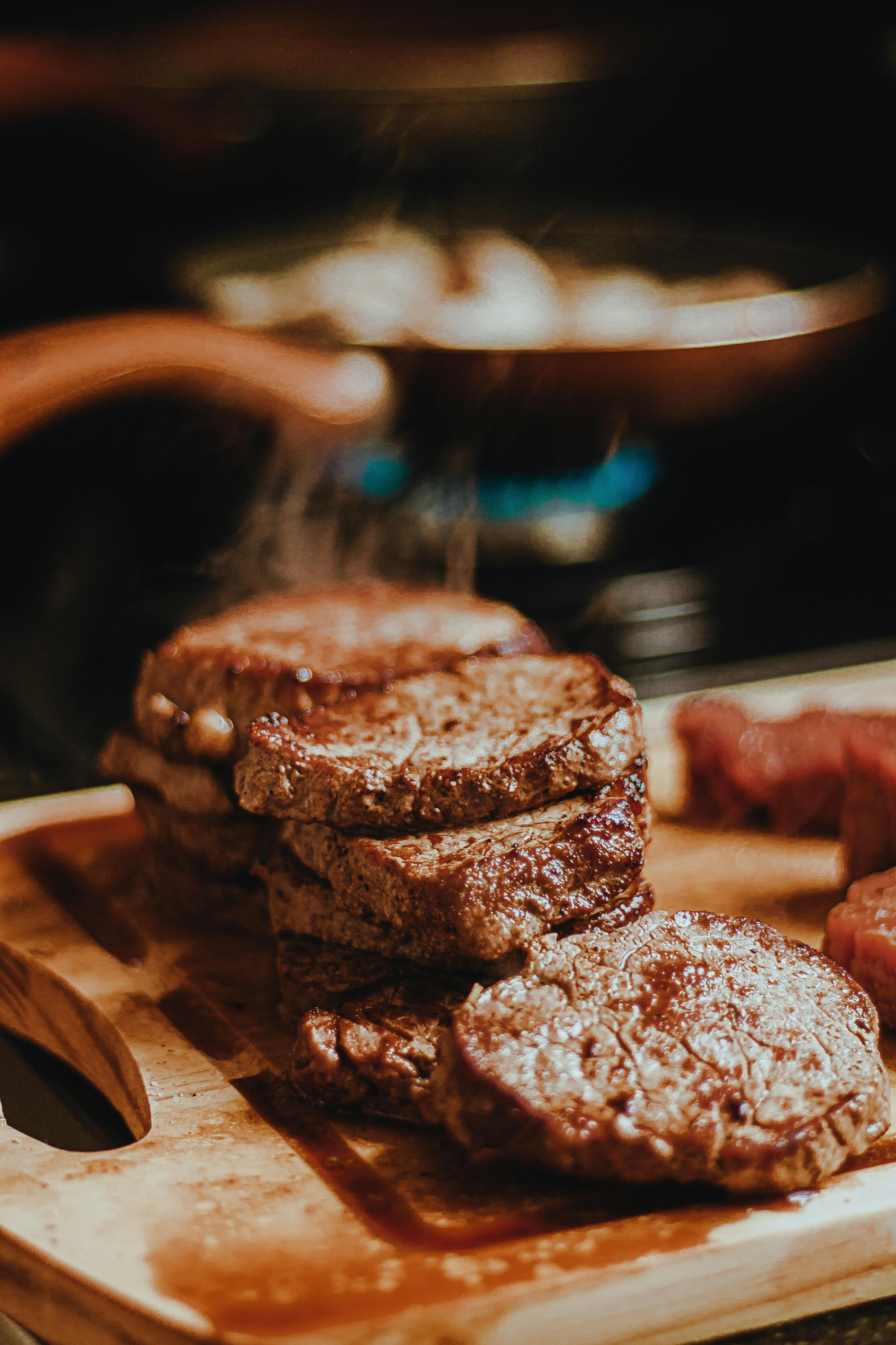 Close-Up Photo of Cooked Meat on Wooden Chopping Board · Free Stock Photo