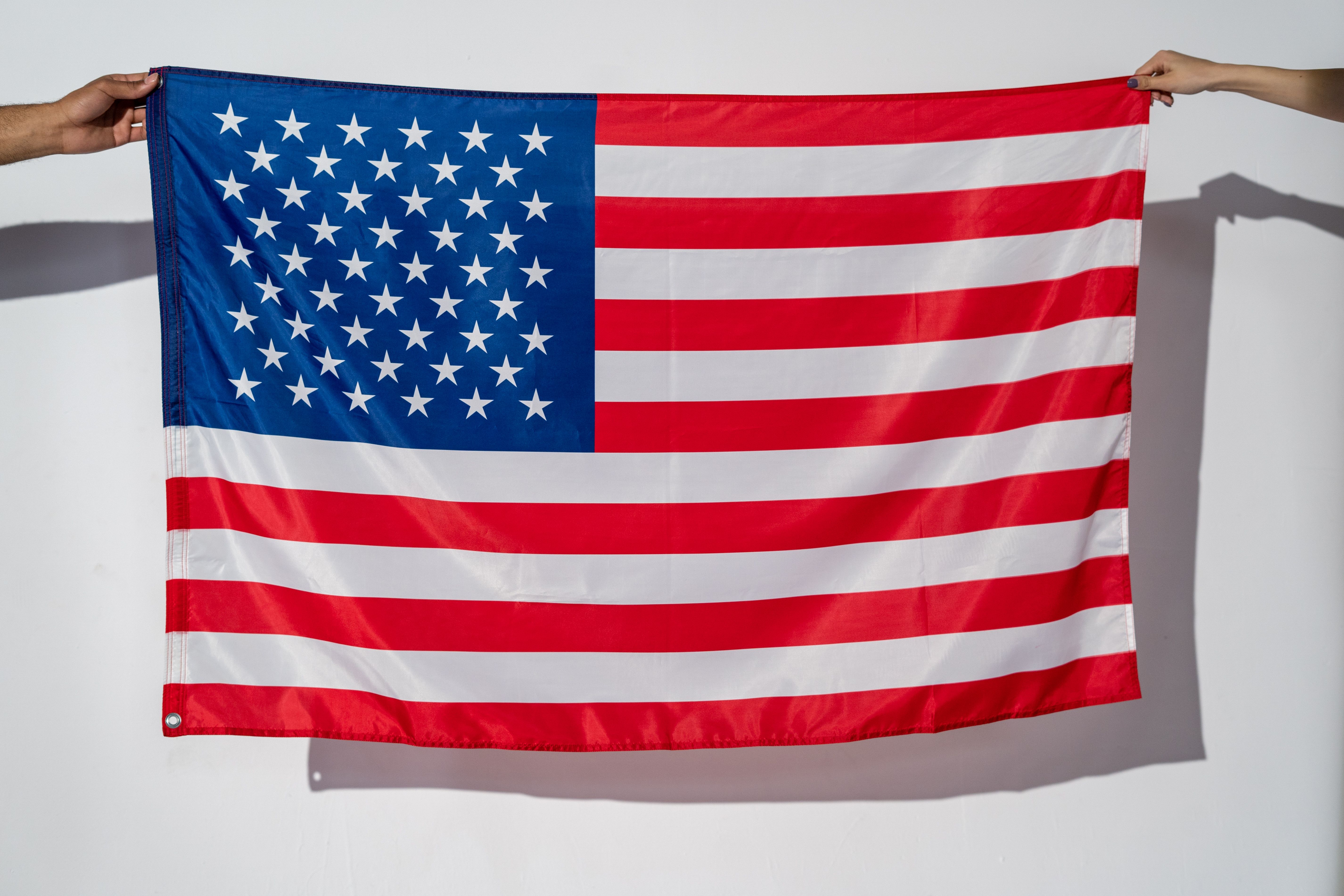 Hands Holding an American Flag · Free Stock Photo