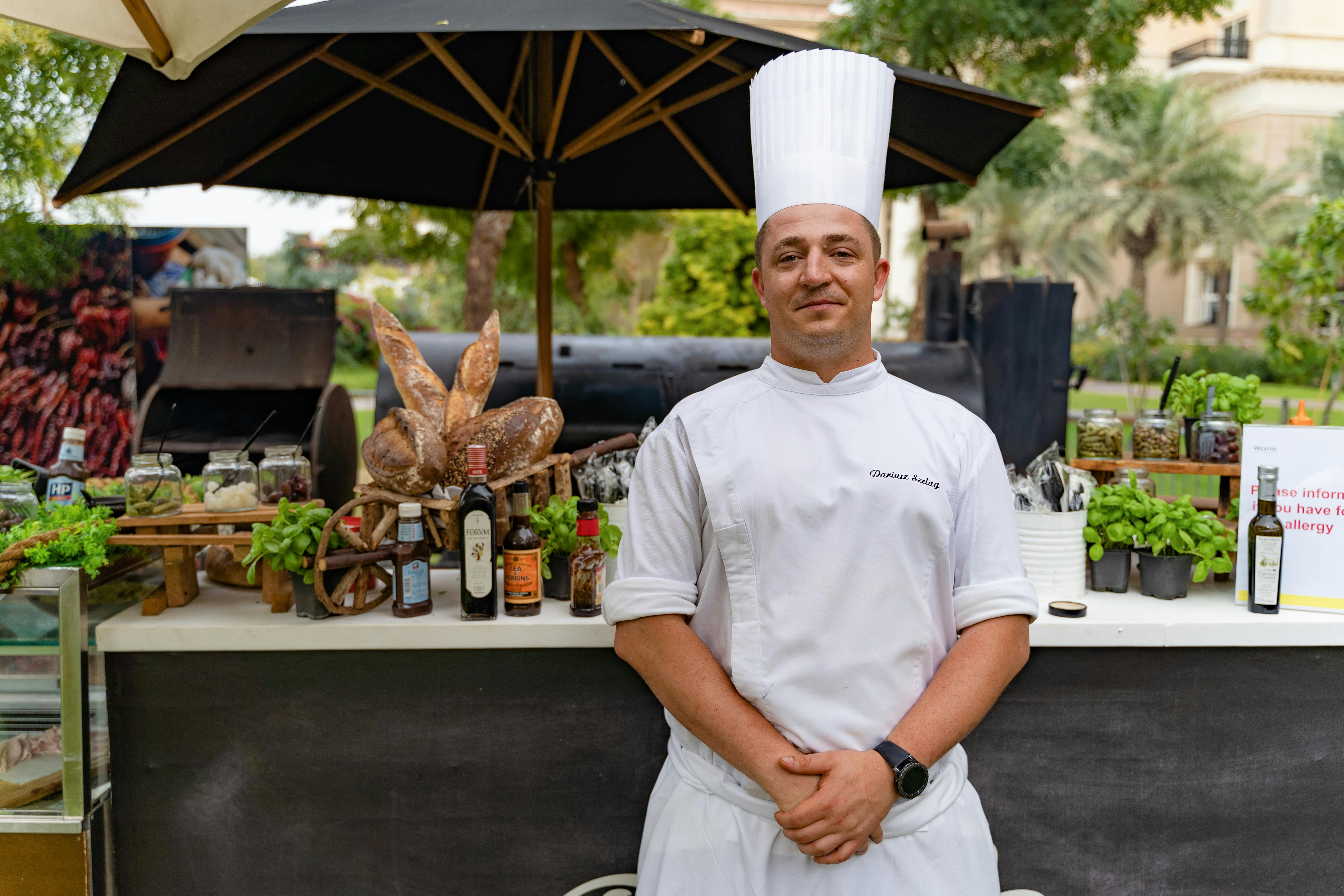 Man Wearing a Chef Hat Standing Beside a Counter · Free Stock Photo
