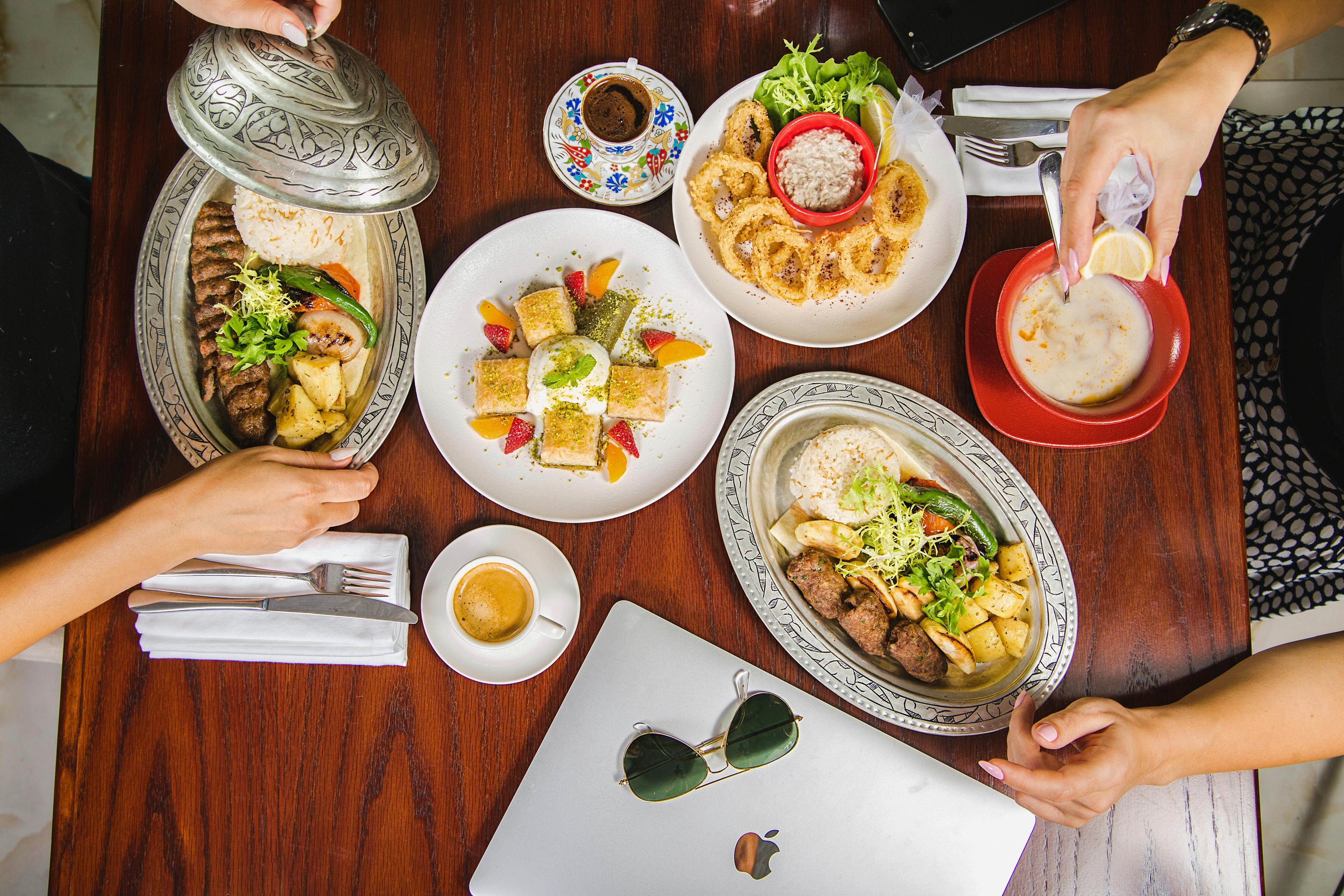 Photo Of People Sitting Beside Wooden Table · Free Stock Photo