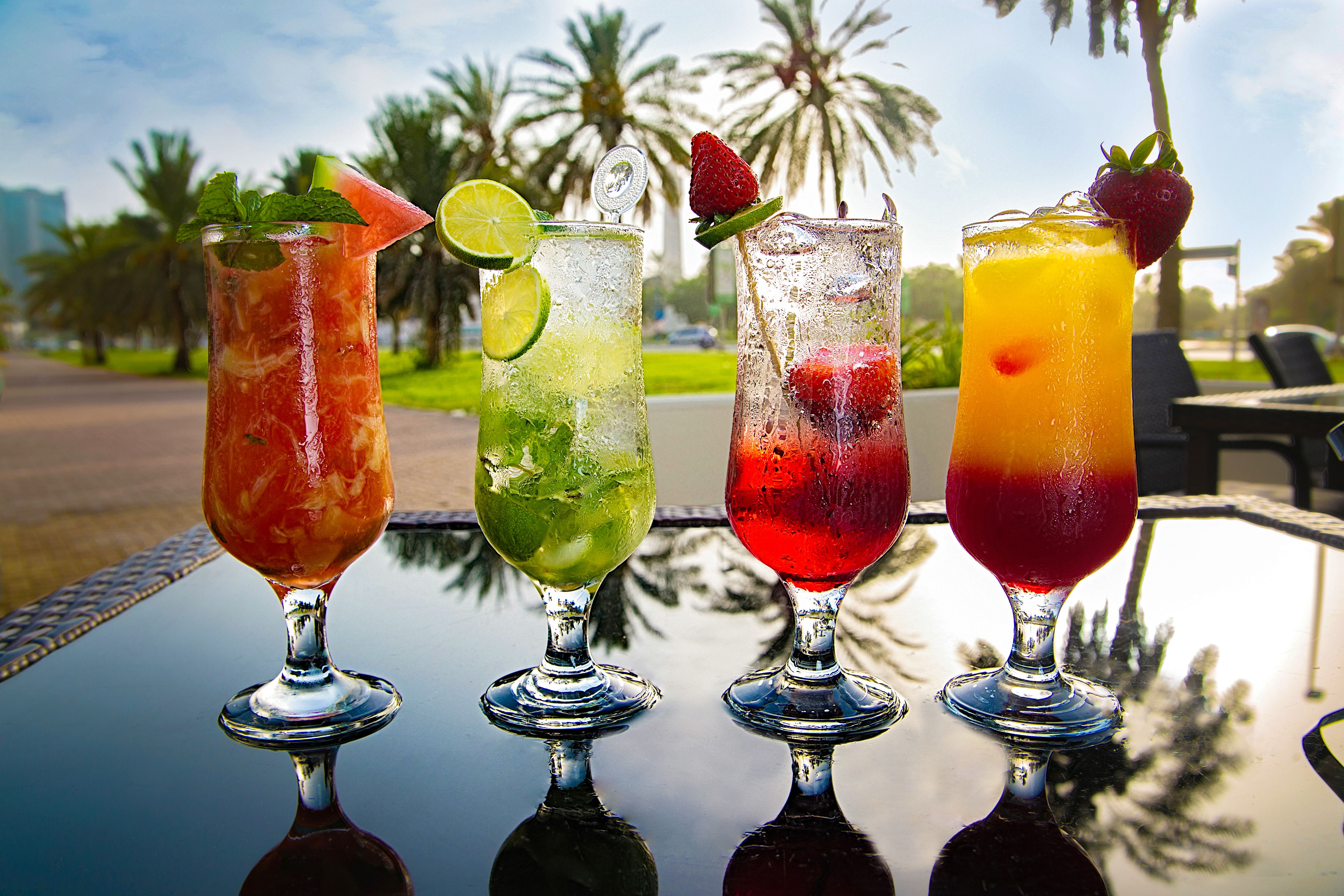 Assorted Cocktail Drinks on a Glass Table · Free Stock Photo