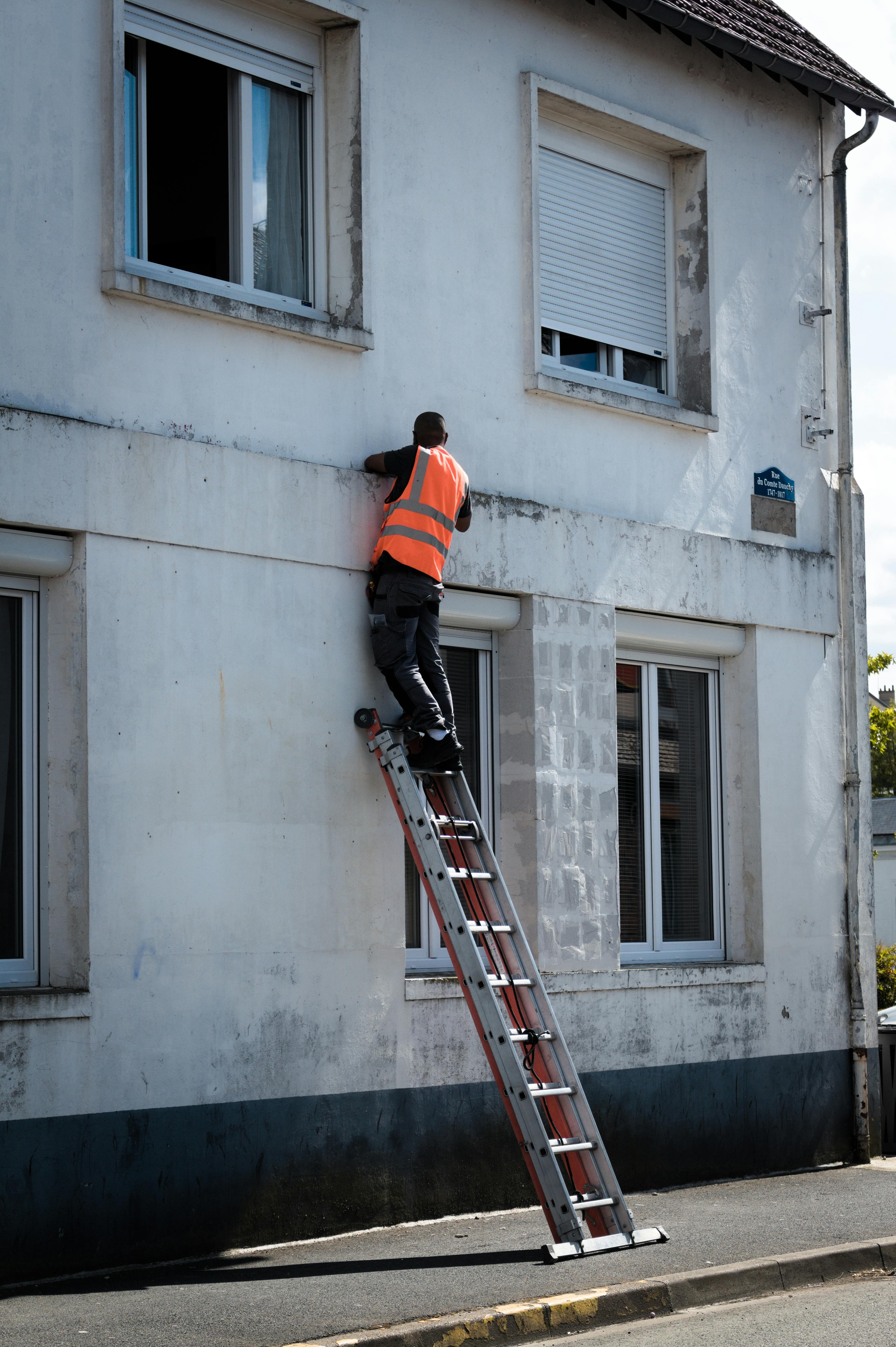 Man Working on Ladder · Free Stock Photo