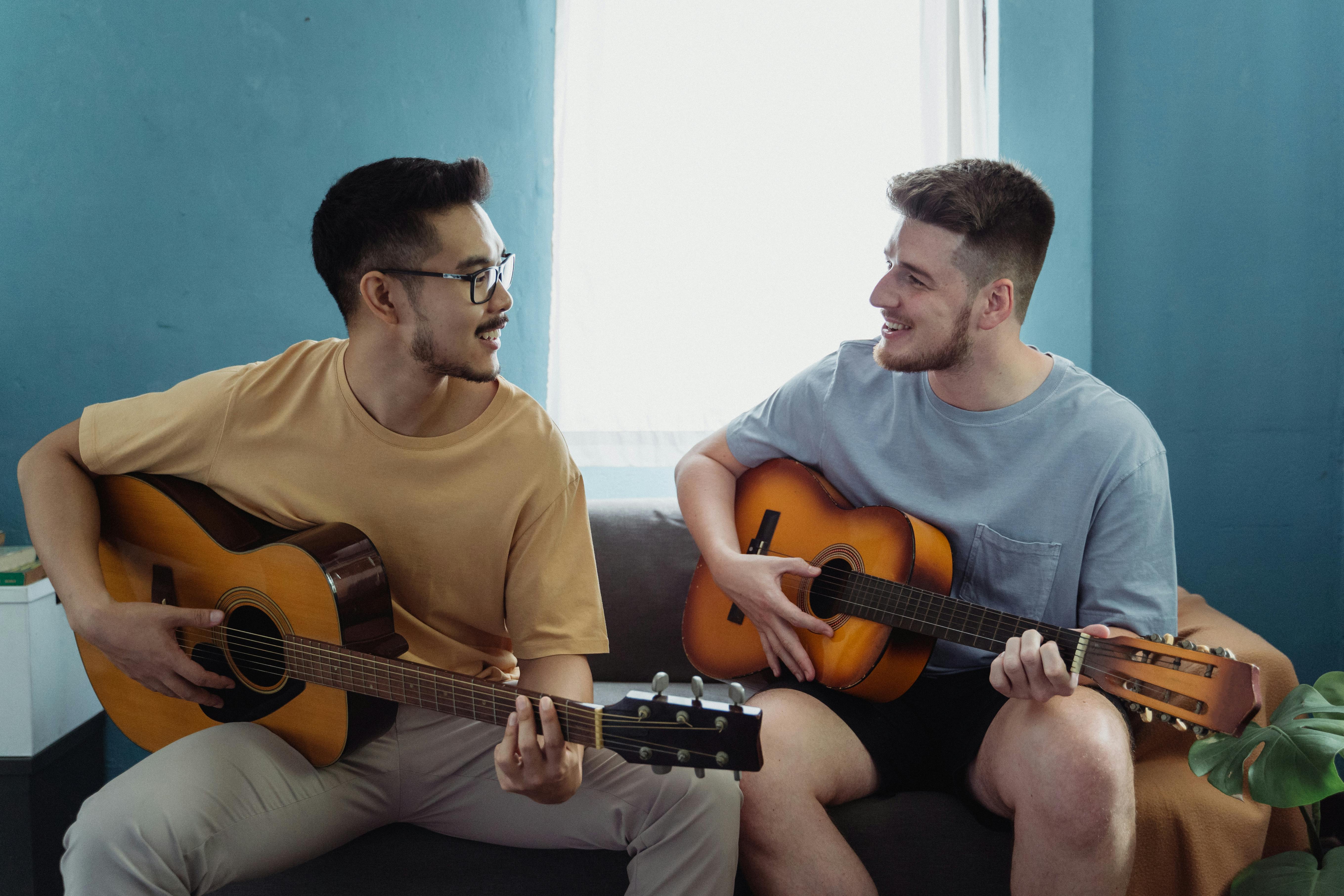 Men Playing the Guitars and Smiling · Free Stock Photo