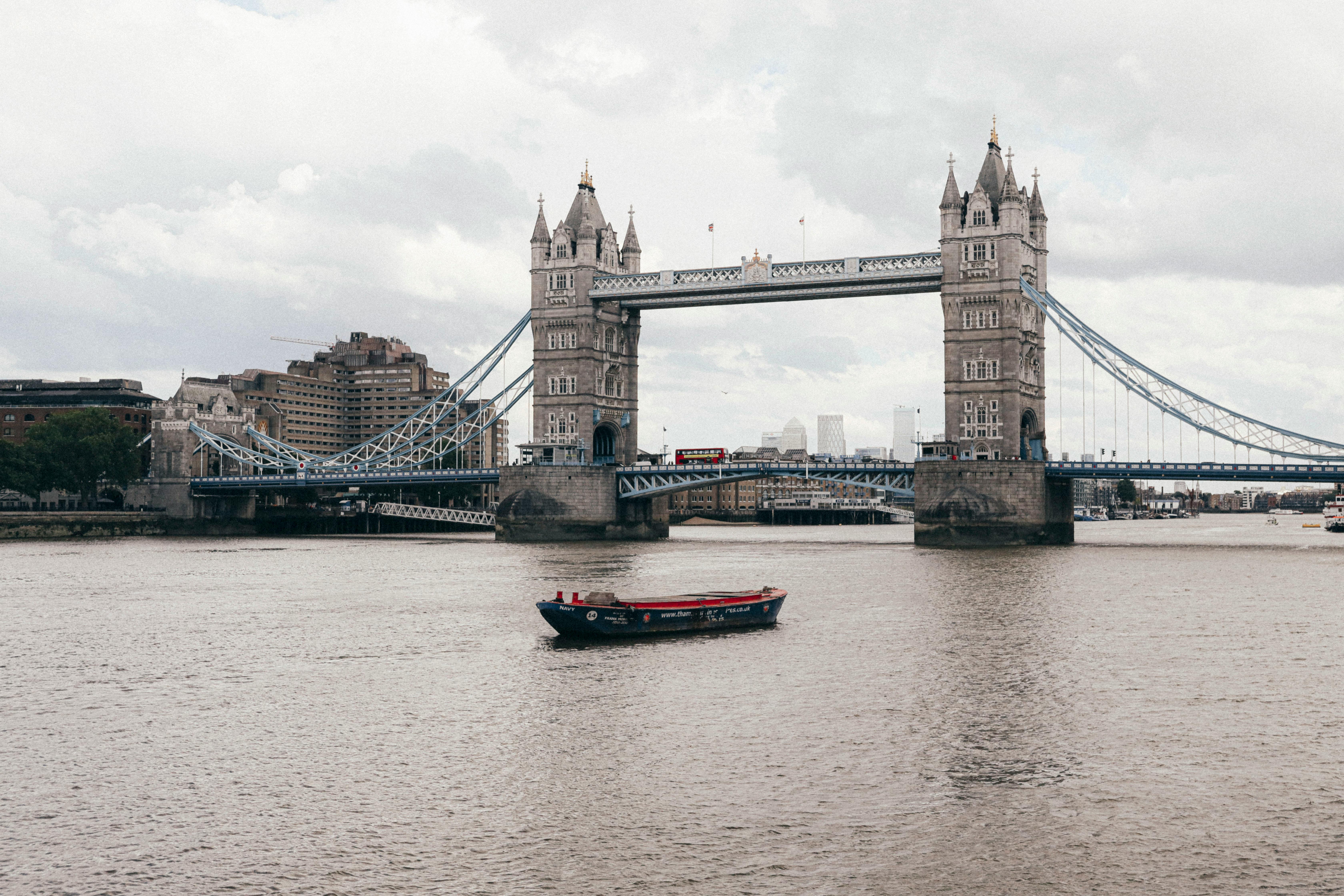 A Wooden Boat Floating on the River Near Tower Bridge · Free Stock Photo