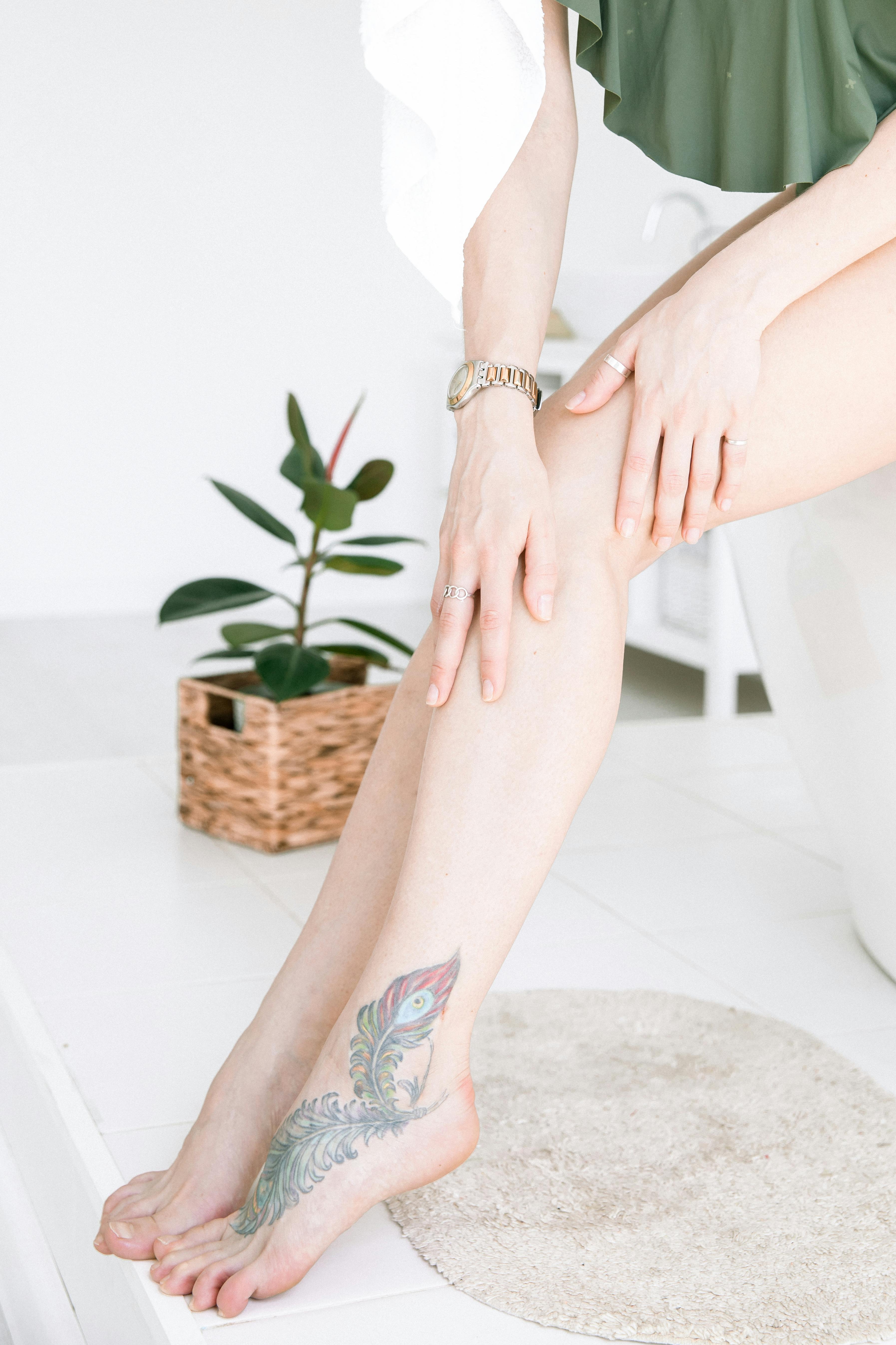 Photo Of Person Holding Her Shin Leg · Free Stock Photo
