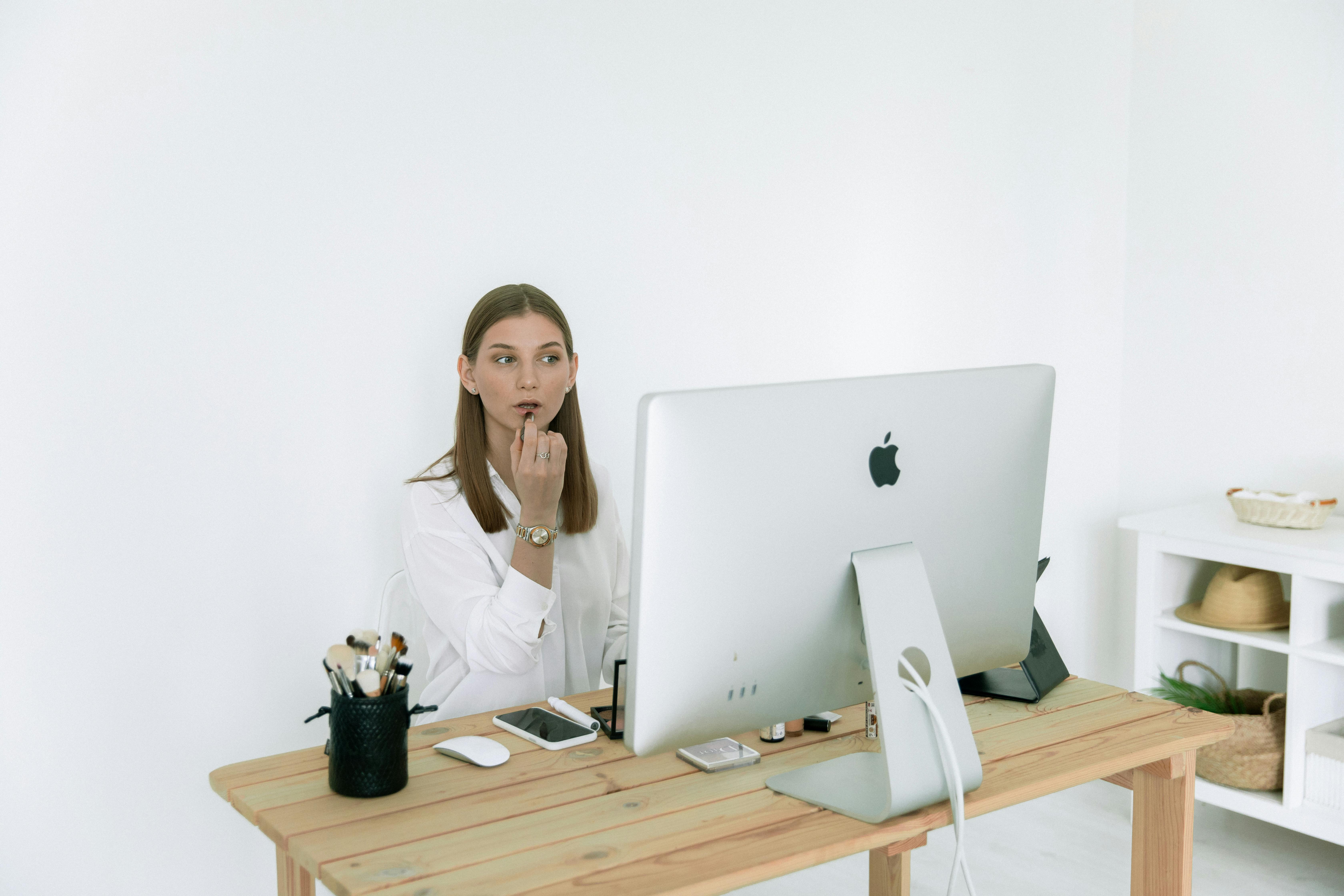 Woman Working On Computer Applying Lotion Photos, Download The BEST ...