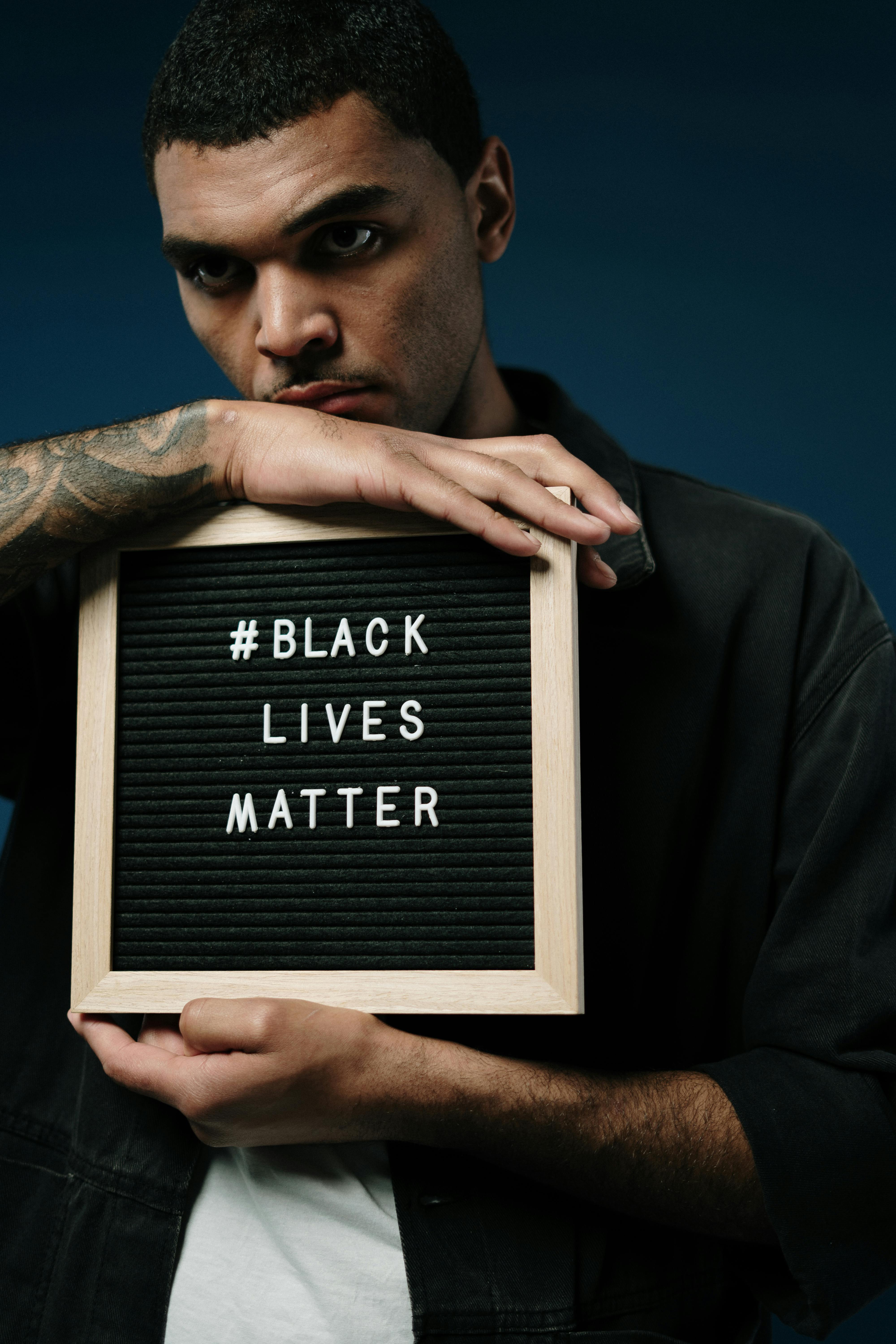 Man Holding a Sign · Free Stock Photo