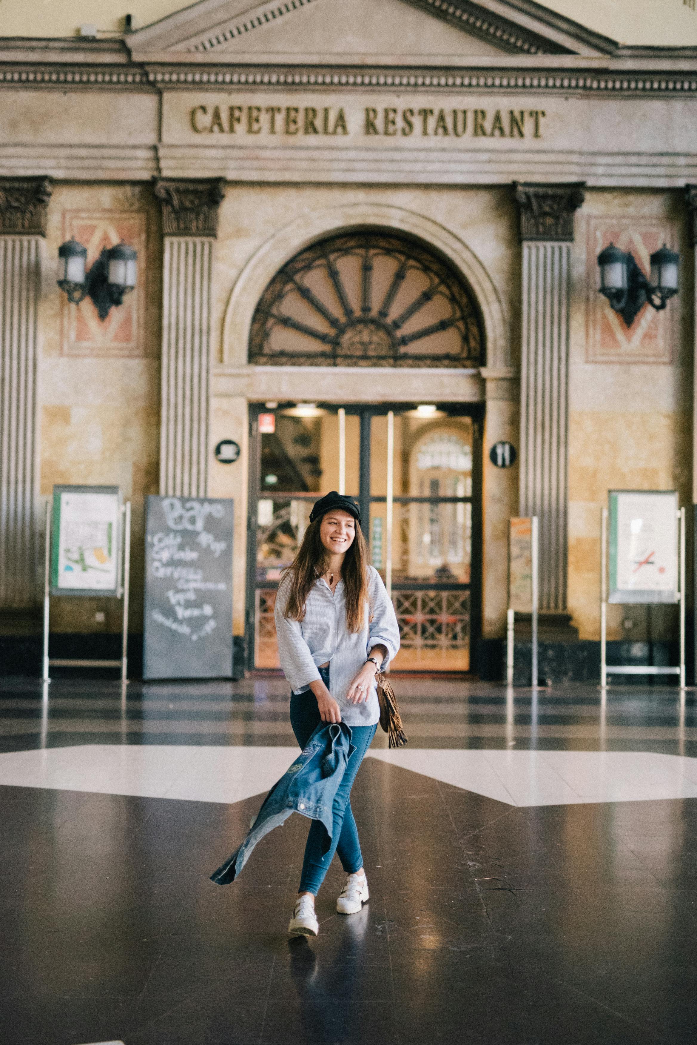 Woman in White Long Sleeve Shirt and Blue Denim Jeans Standing Infront ...