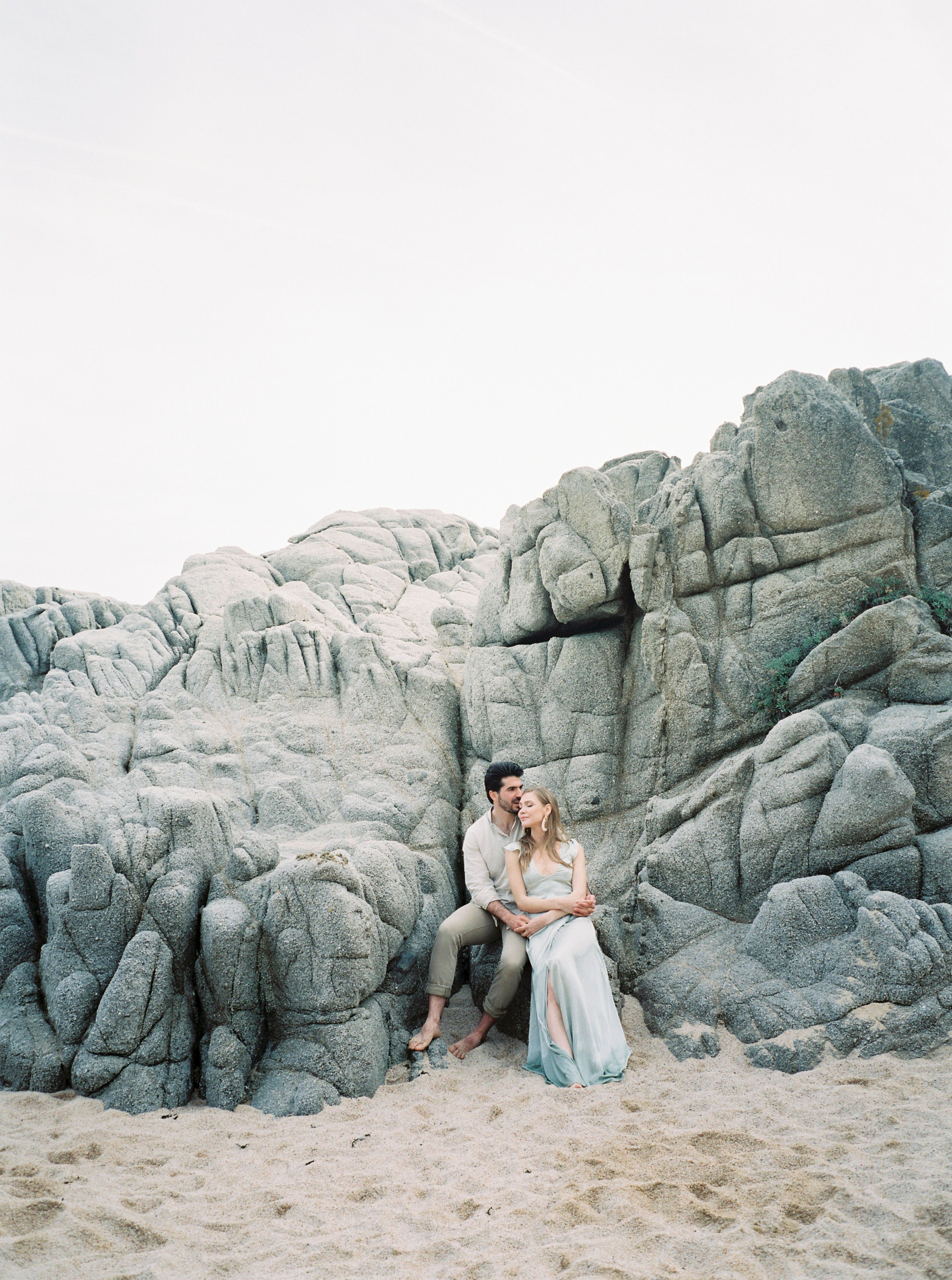 A Couple Hugging while Sitting on a Rock · Free Stock Photo