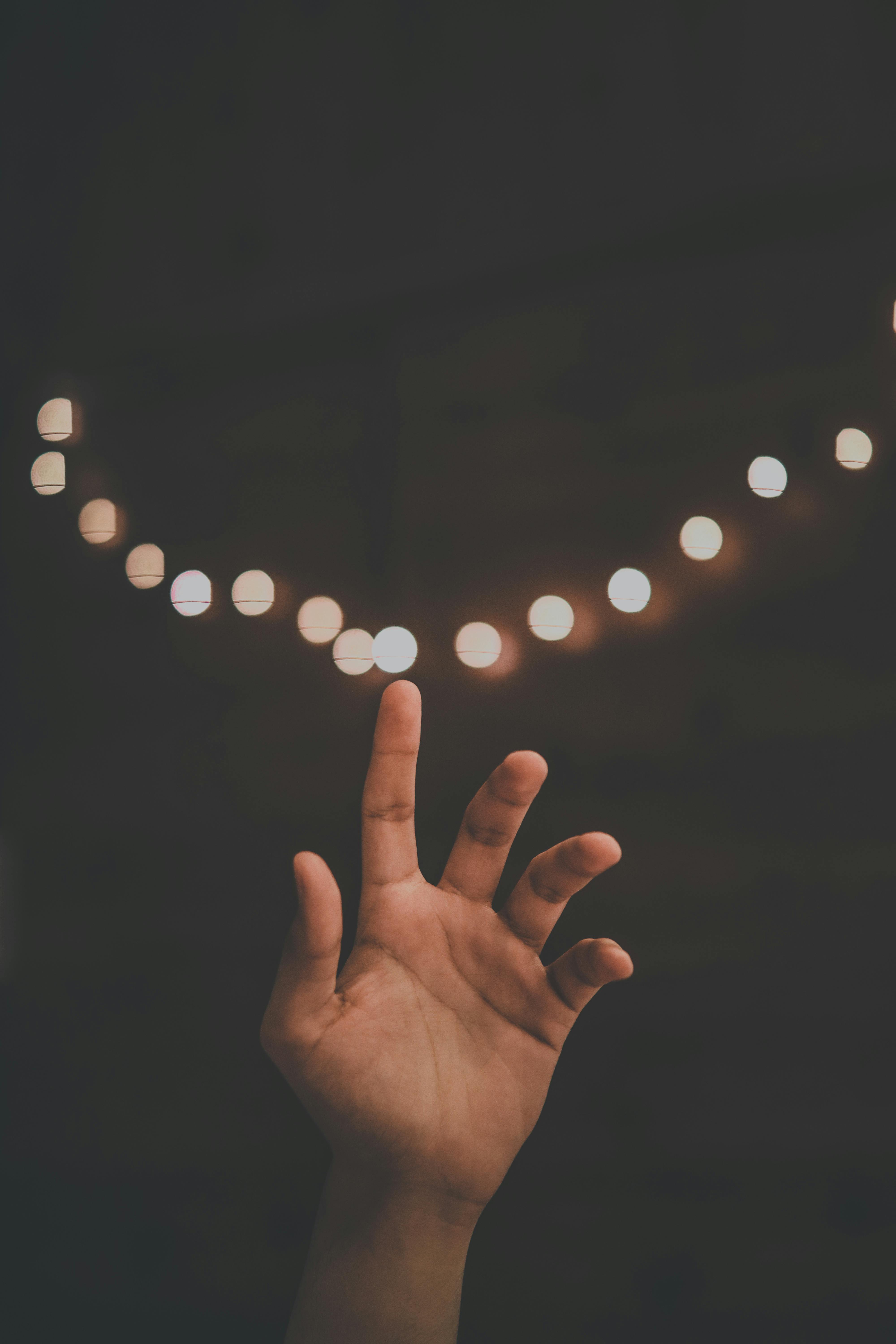 Hand Touching Lights · Free Stock Photo