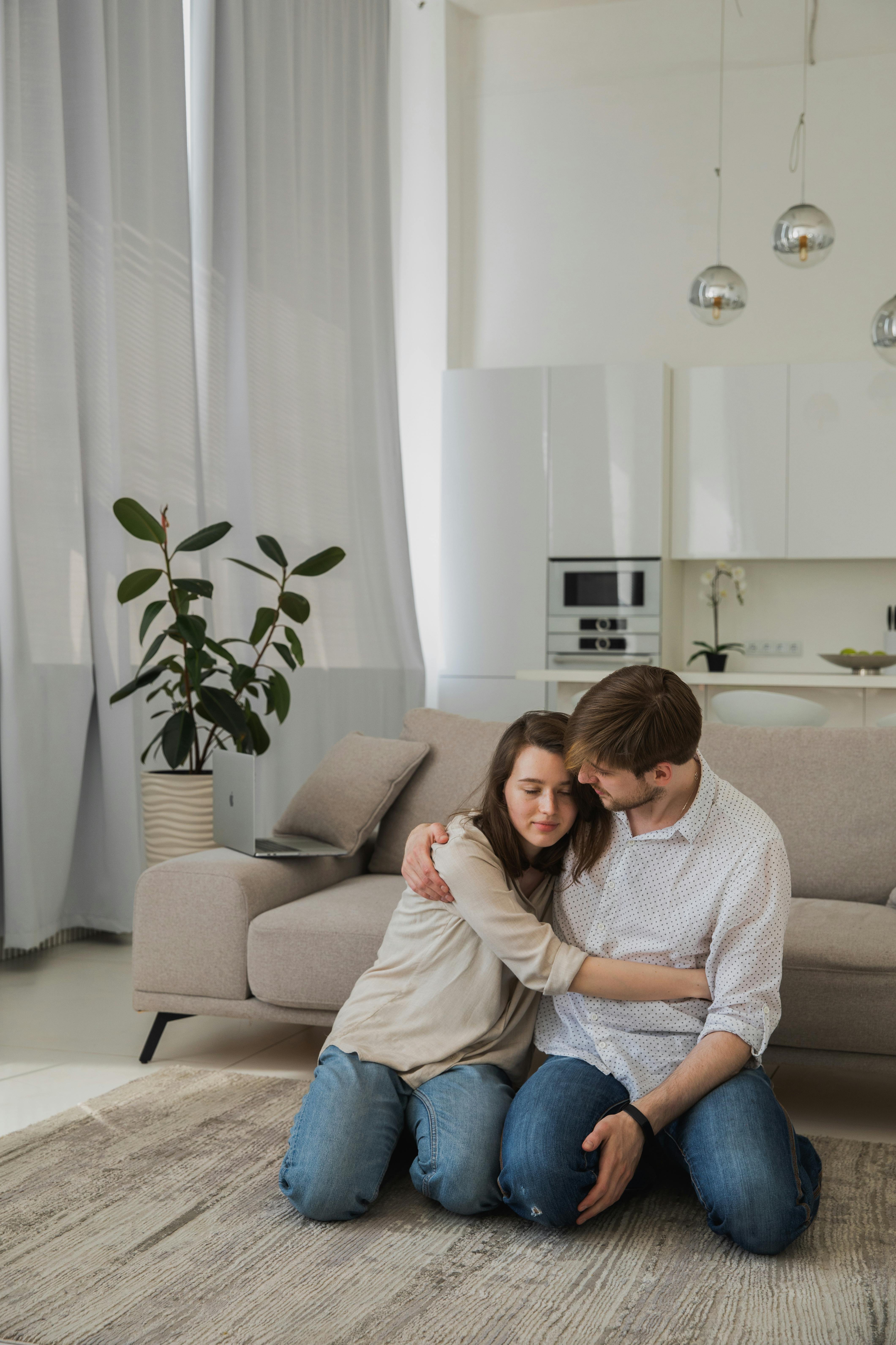 A Couple Kneeling Down in a Living Room · Free Stock Photo