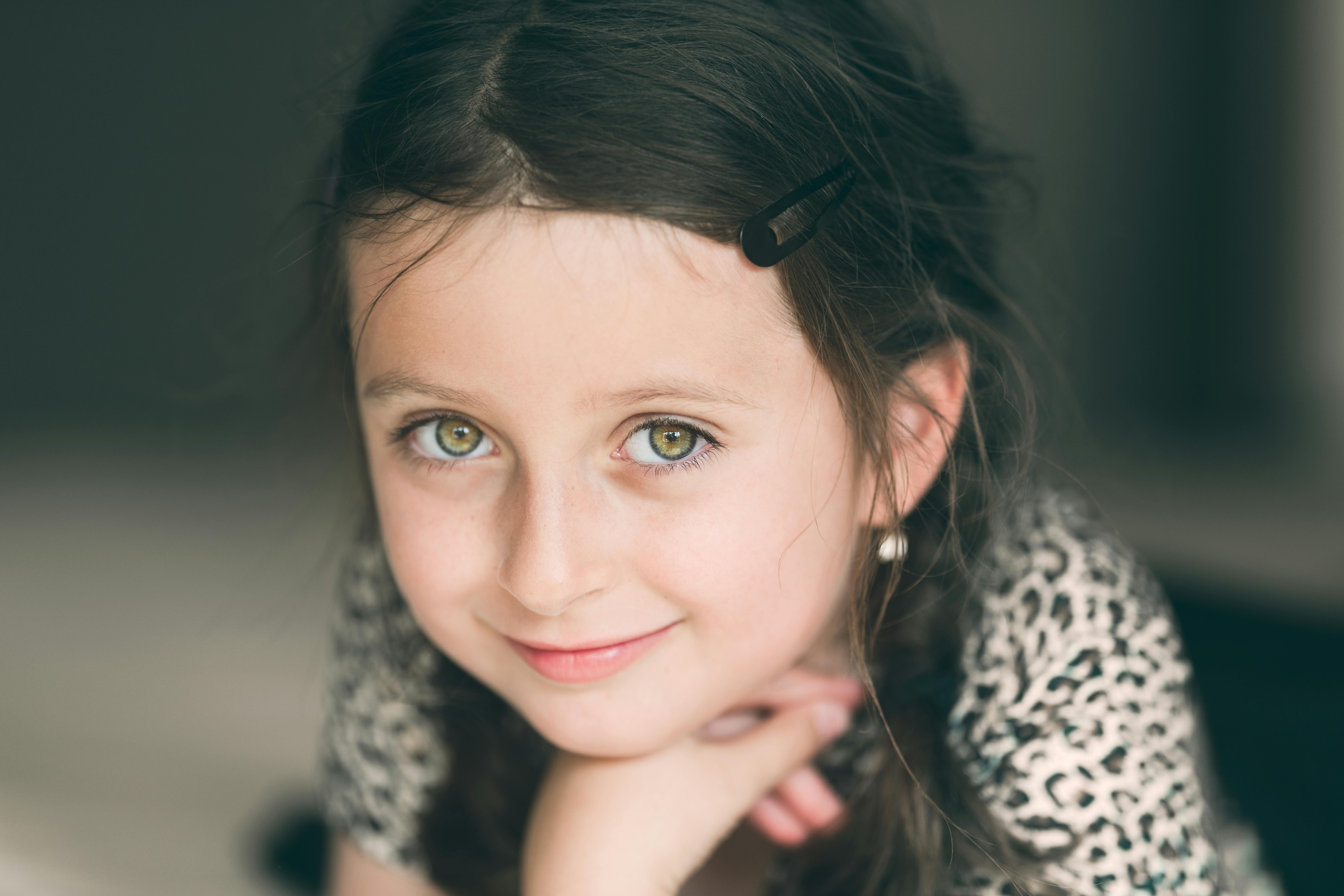 Little girl with green eyes looking at camera · Free Stock Photo