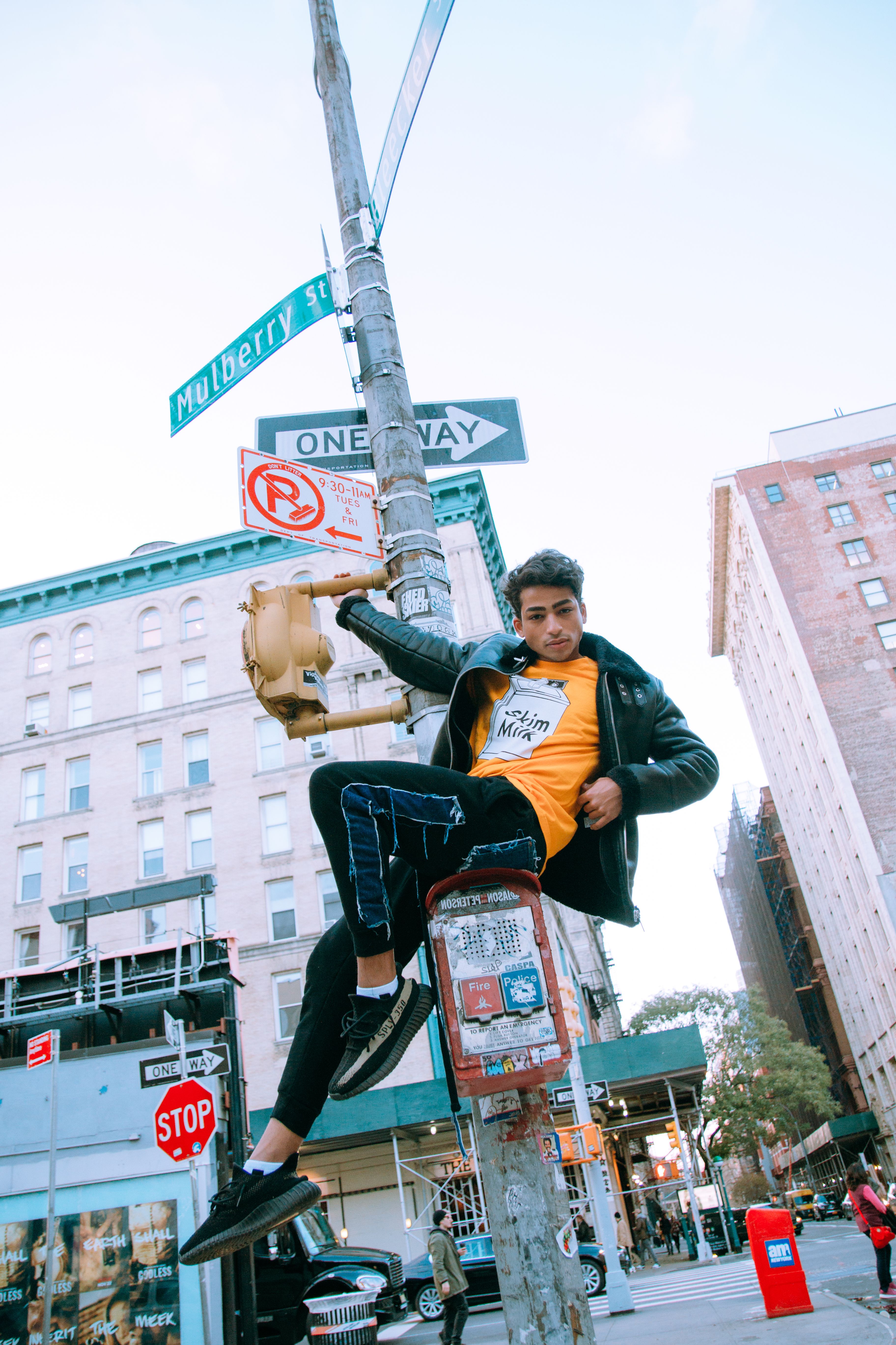 Photo of Man Sitting on Metal Post · Free Stock Photo