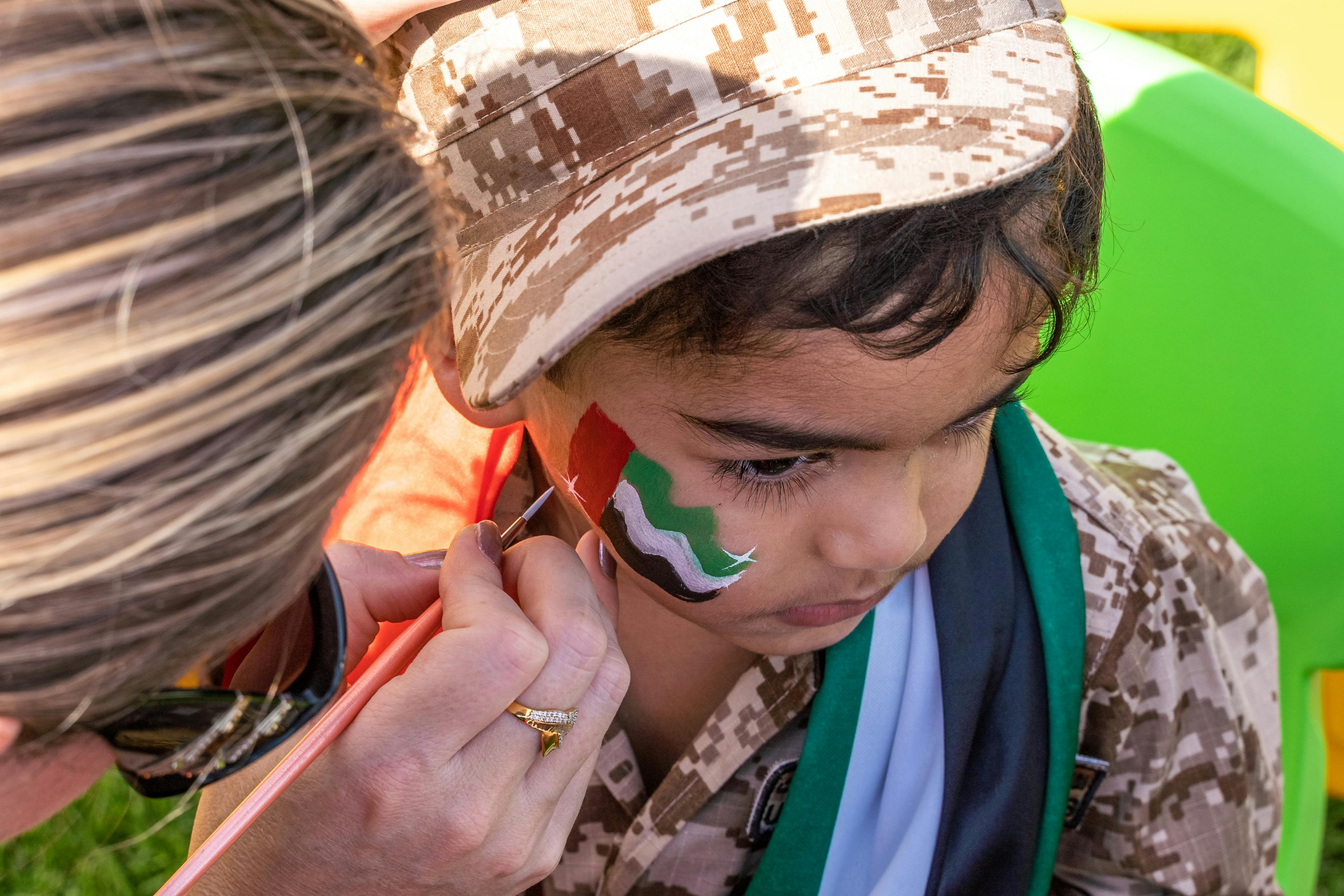 Person Applying Face Paint on a Girl · Free Stock Photo