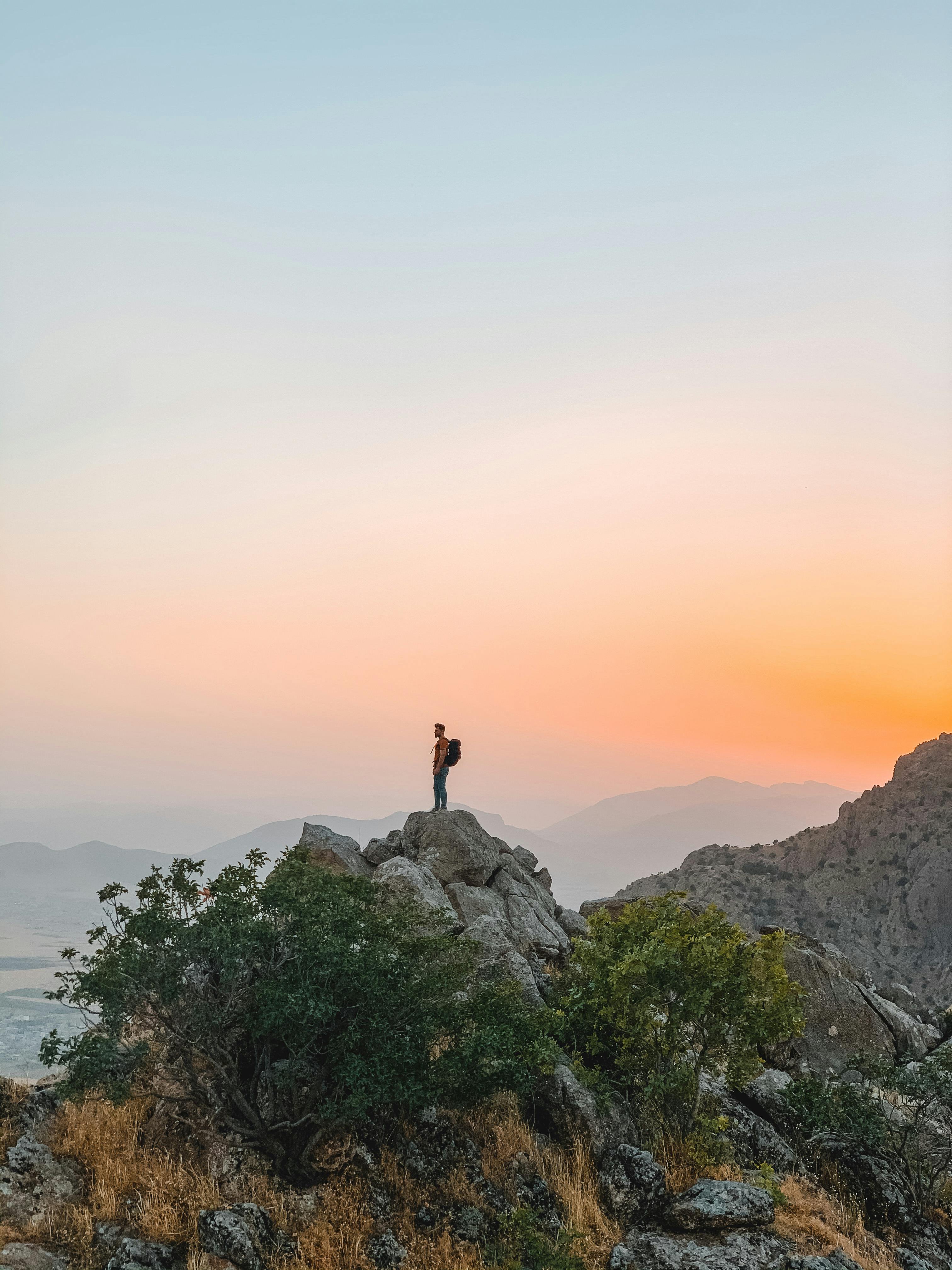 A Man Standing on Top of a Mountain · Free Stock Photo