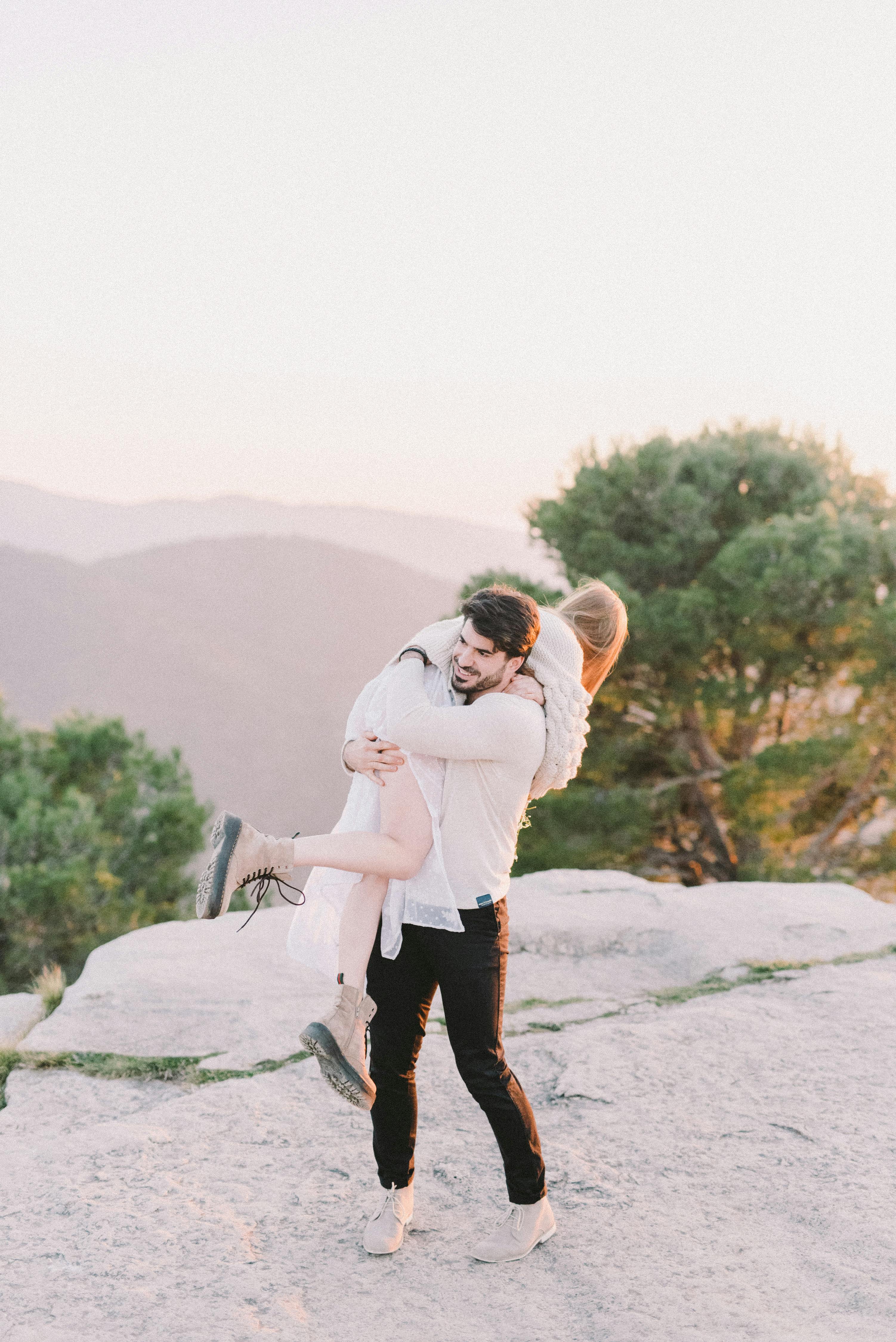 A Man Carrying a Woman on His Shoulder · Free Stock Photo