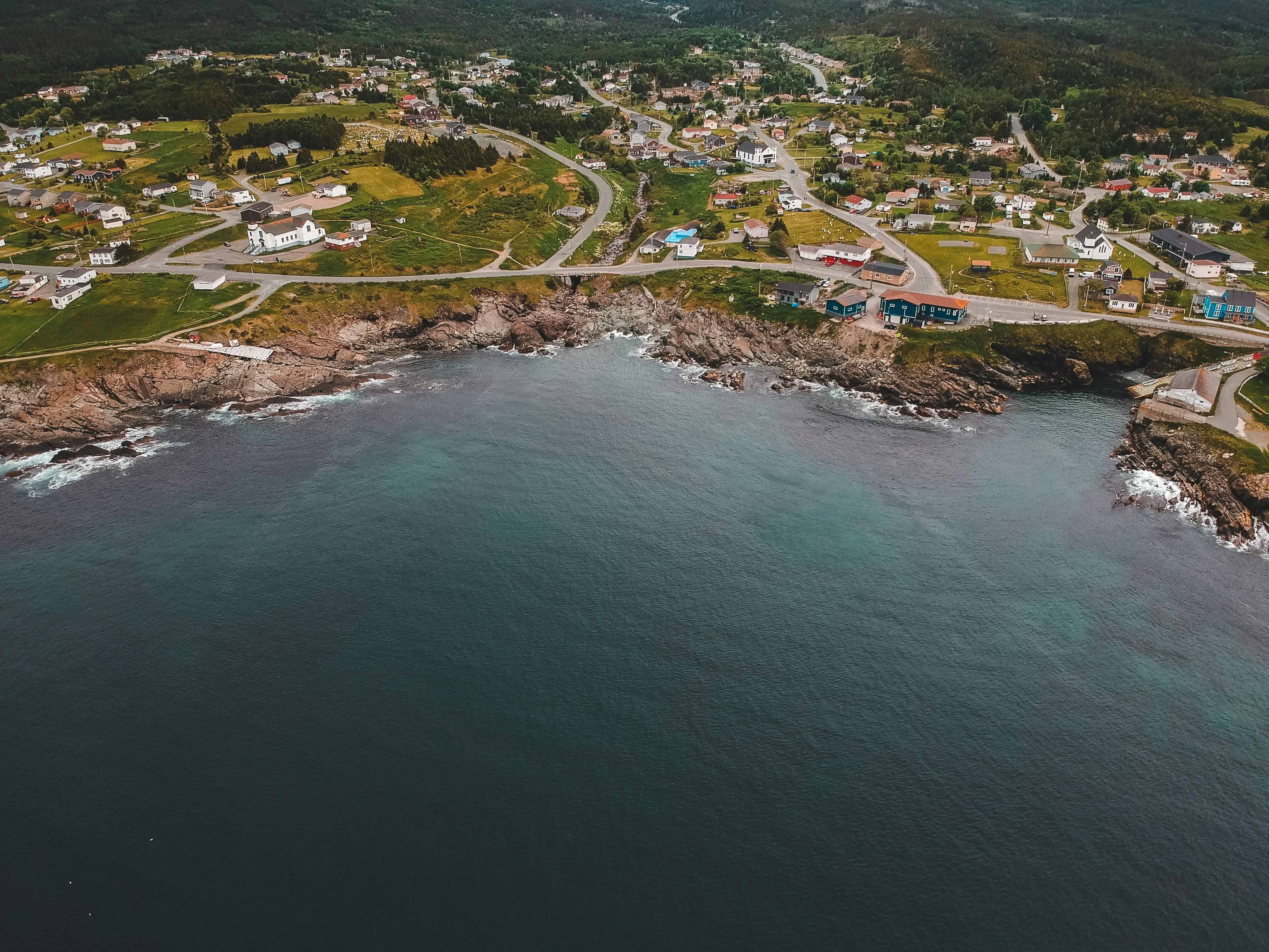 Housing complex near roadways and ocean in countryside · Free Stock Photo