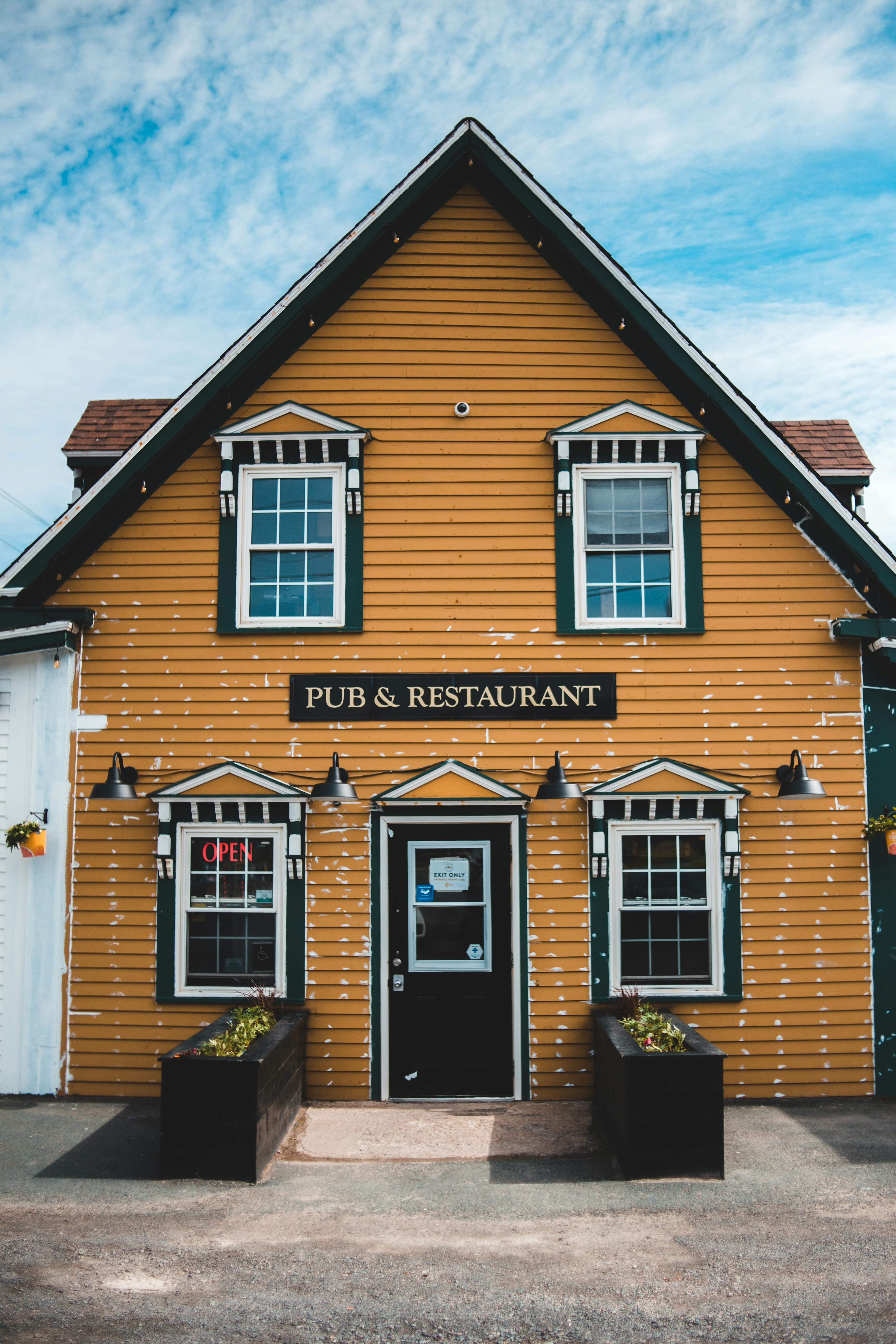 Old wooden pub facade near road in city · Free Stock Photo