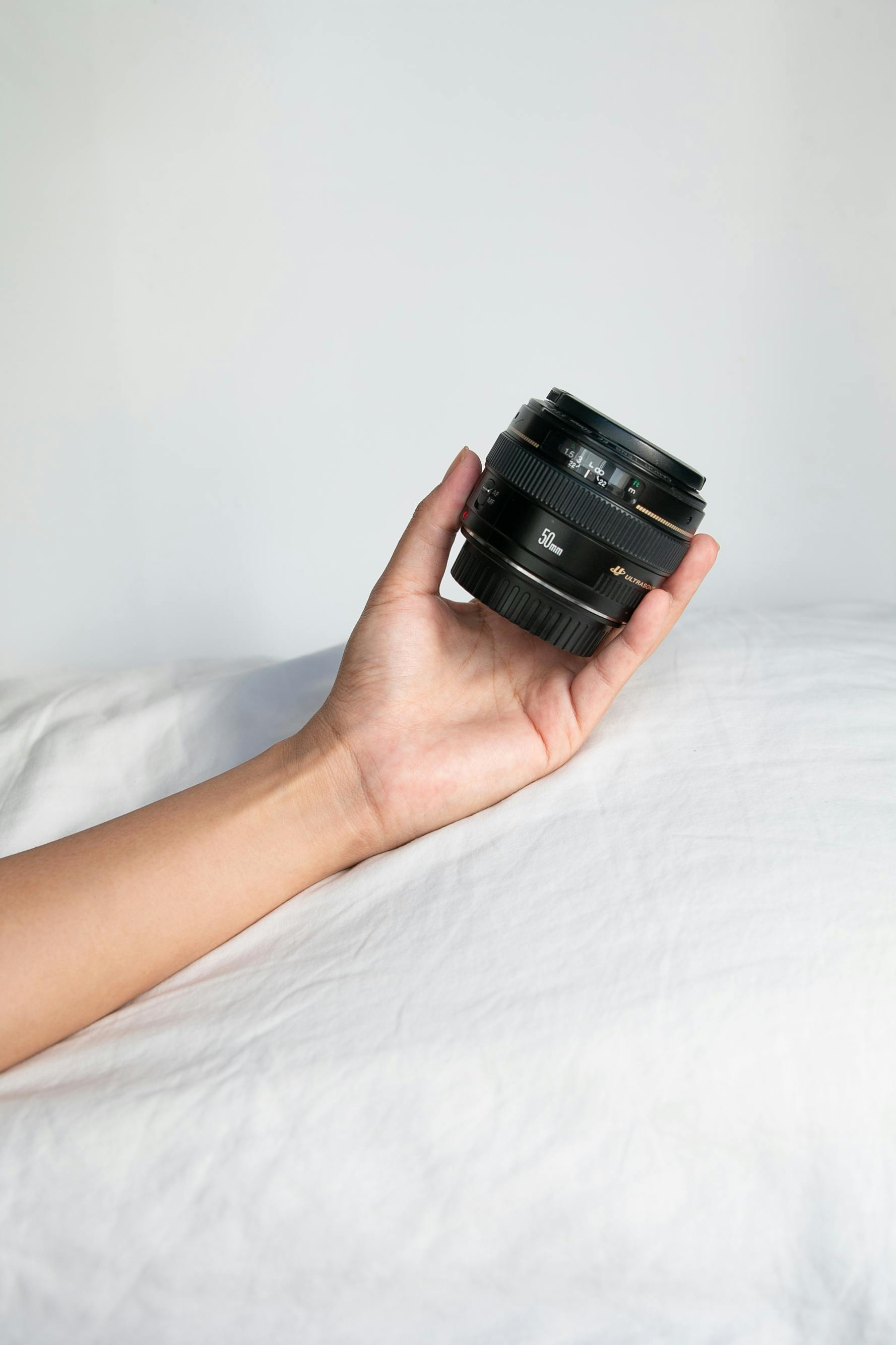 Person Holding Camera Lens in Camera Bag · Free Stock Photo