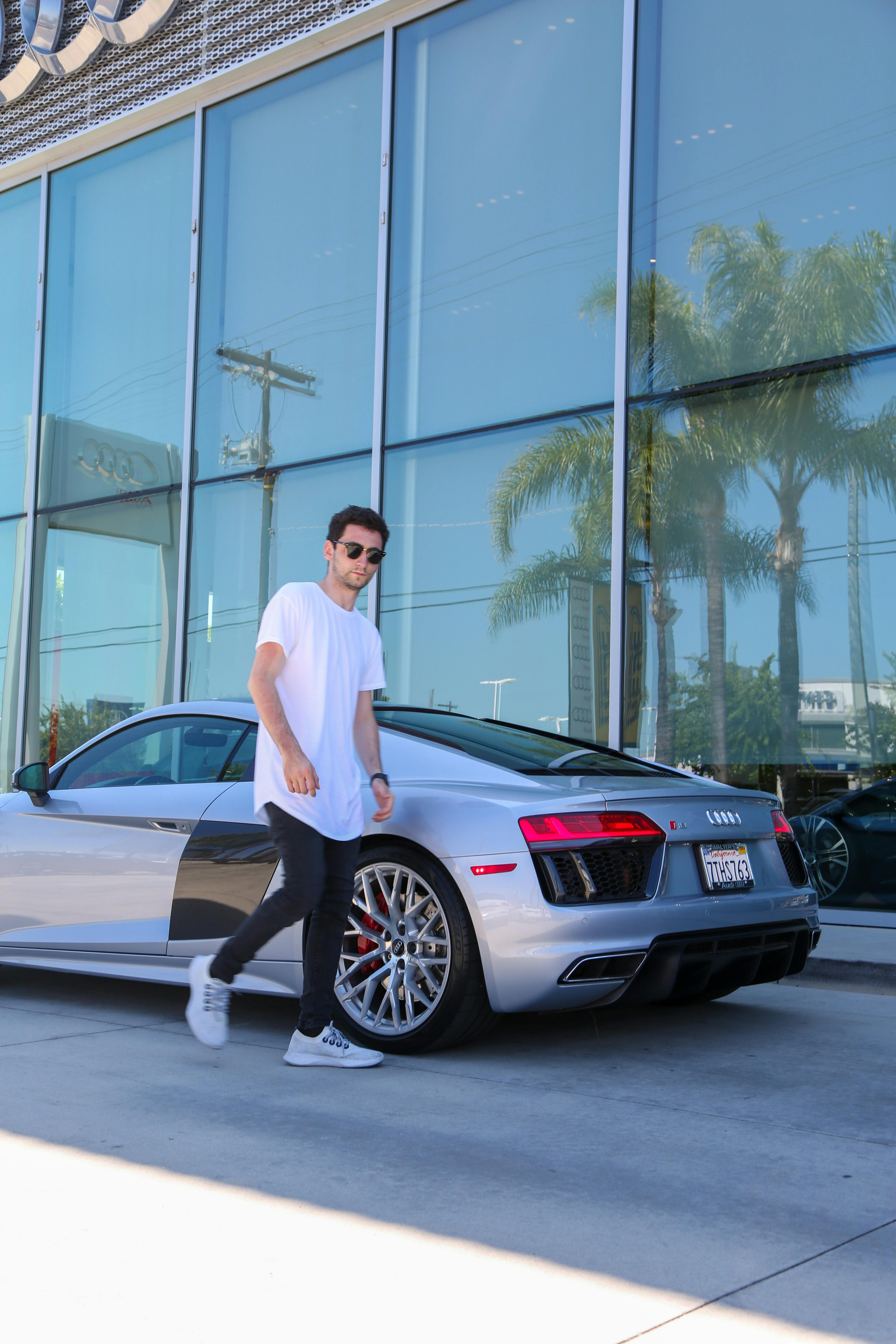 Young man by luxury car on street · Free Stock Photo