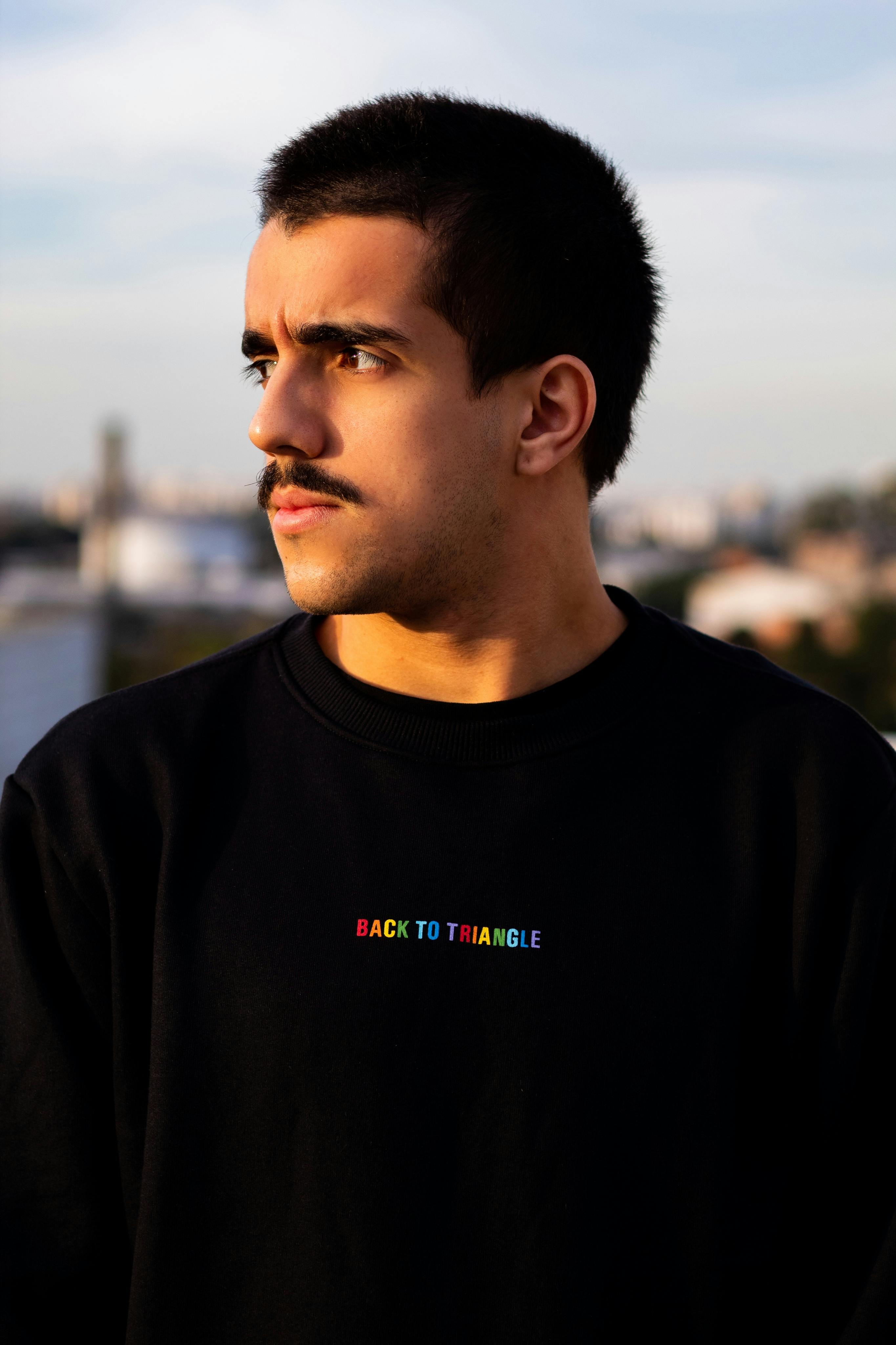 Man with a Mustache Carrying a Camera · Free Stock Photo