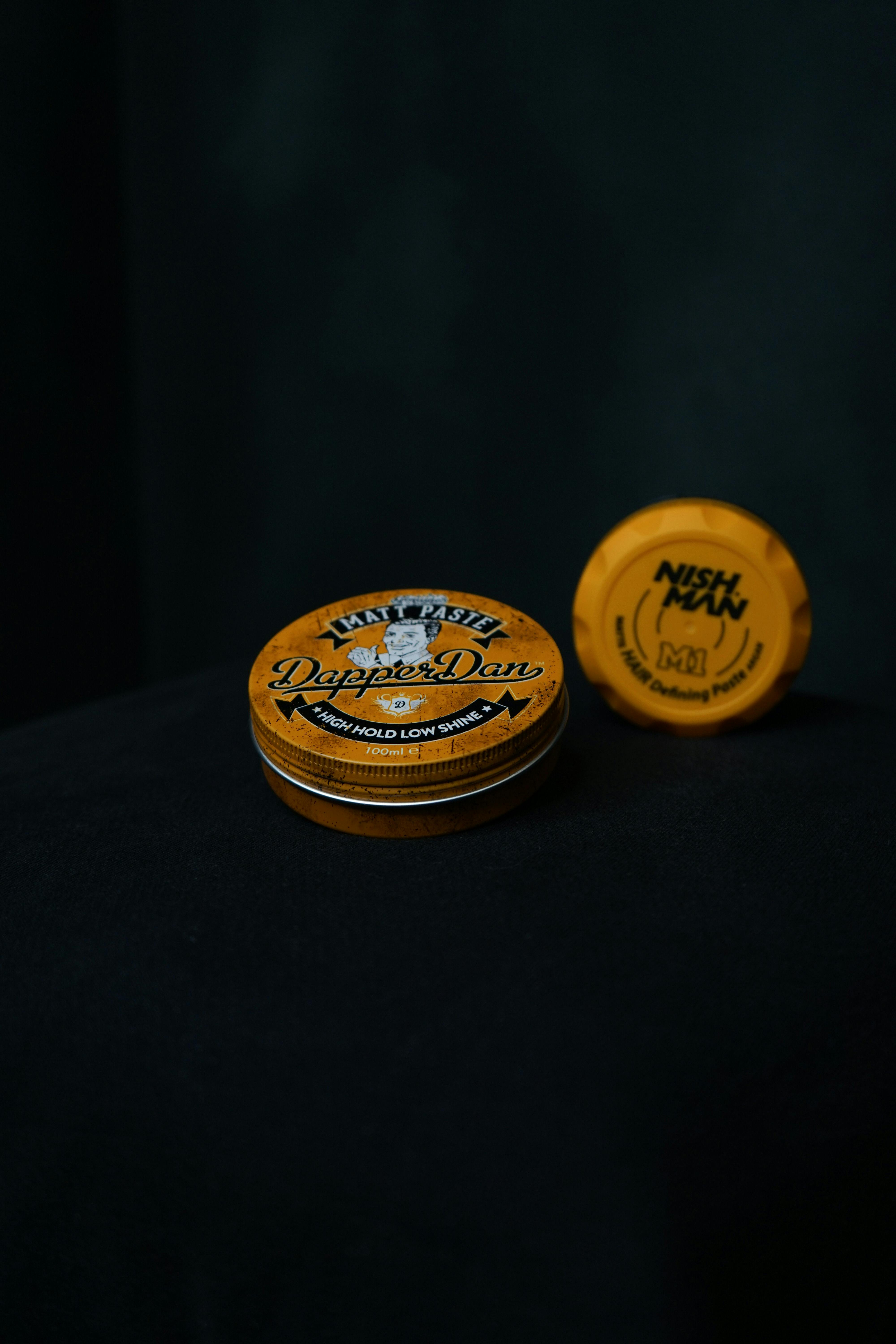 A Dapper Dan High Hold Low Shine Matt Paste and a Nish Man Products on Dark Background · Free ...