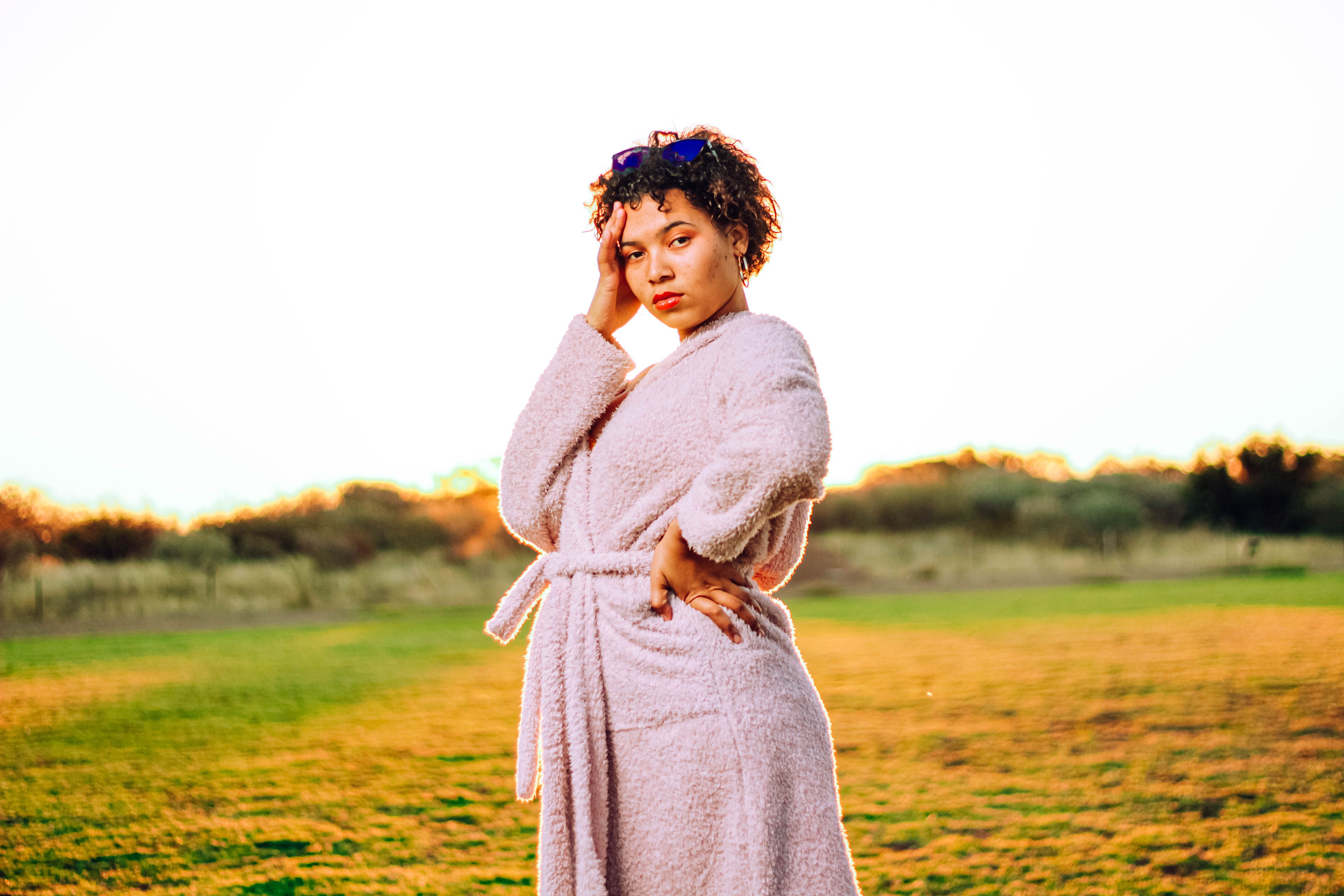 Cool young black lady on grass in nature · Free Stock Photo