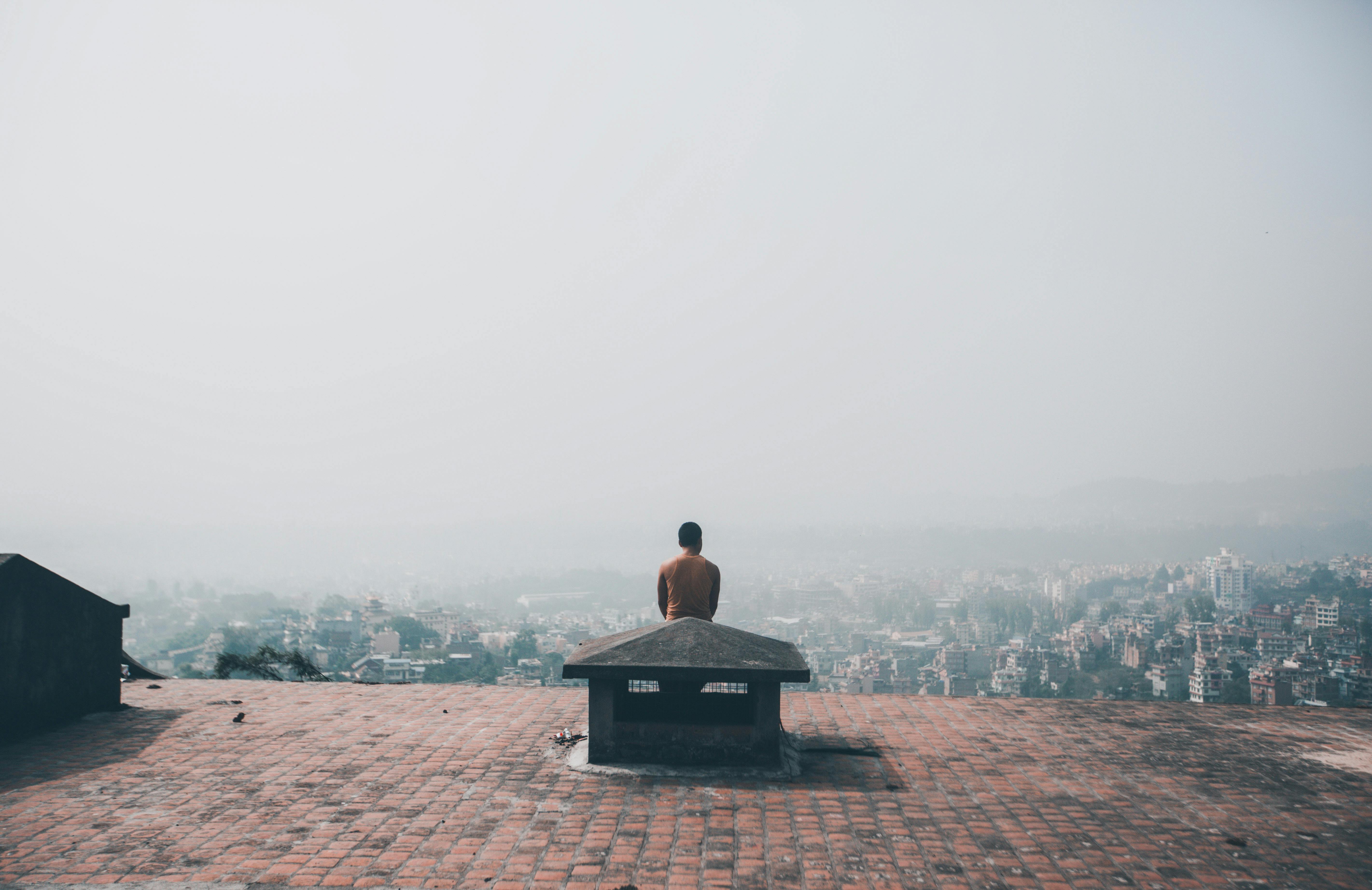 A Man Sitting on the Rooftop · Free Stock Photo