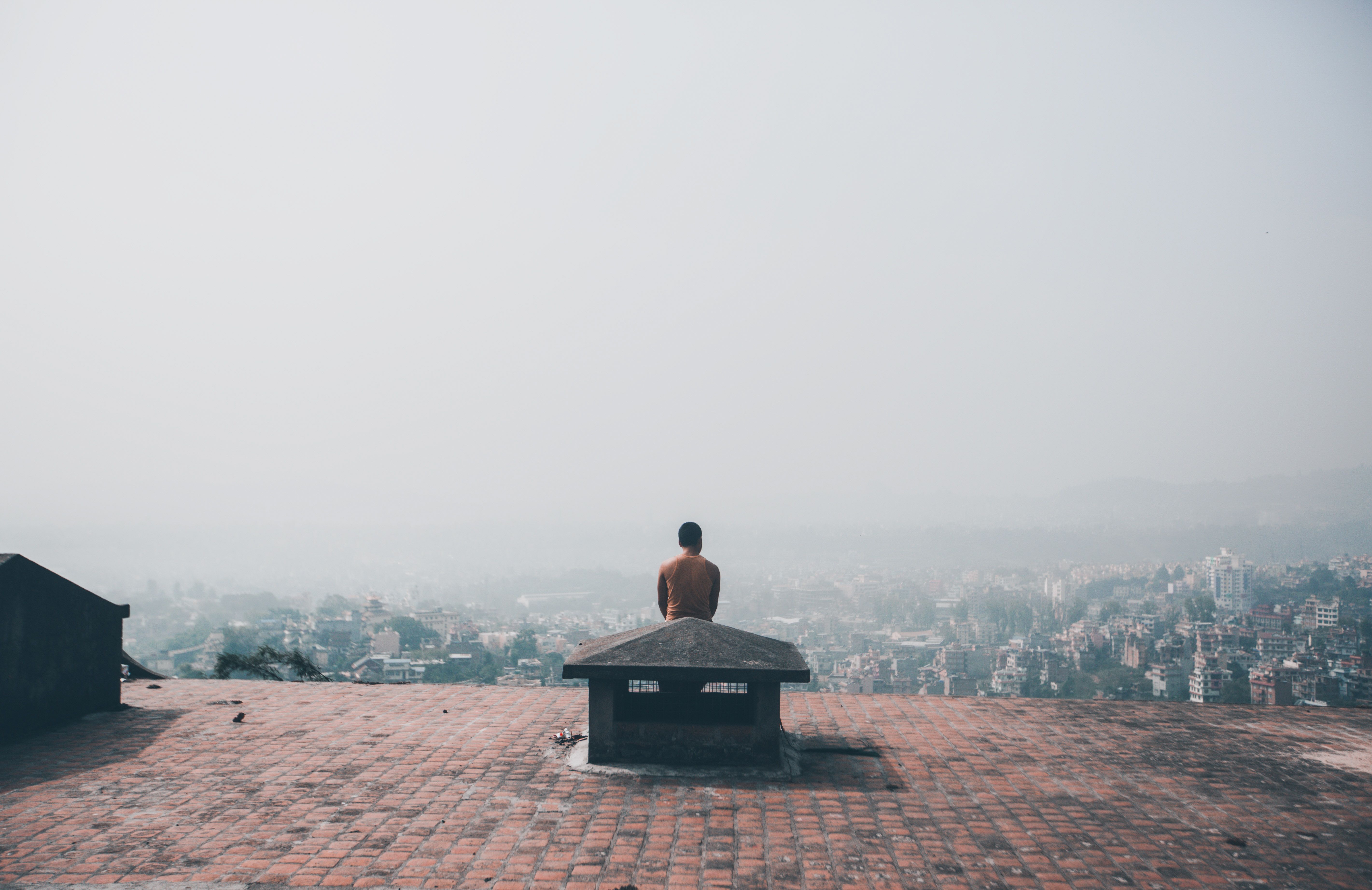 Woman Looking at a Cityscape from the Rooftop · Free Stock Photo