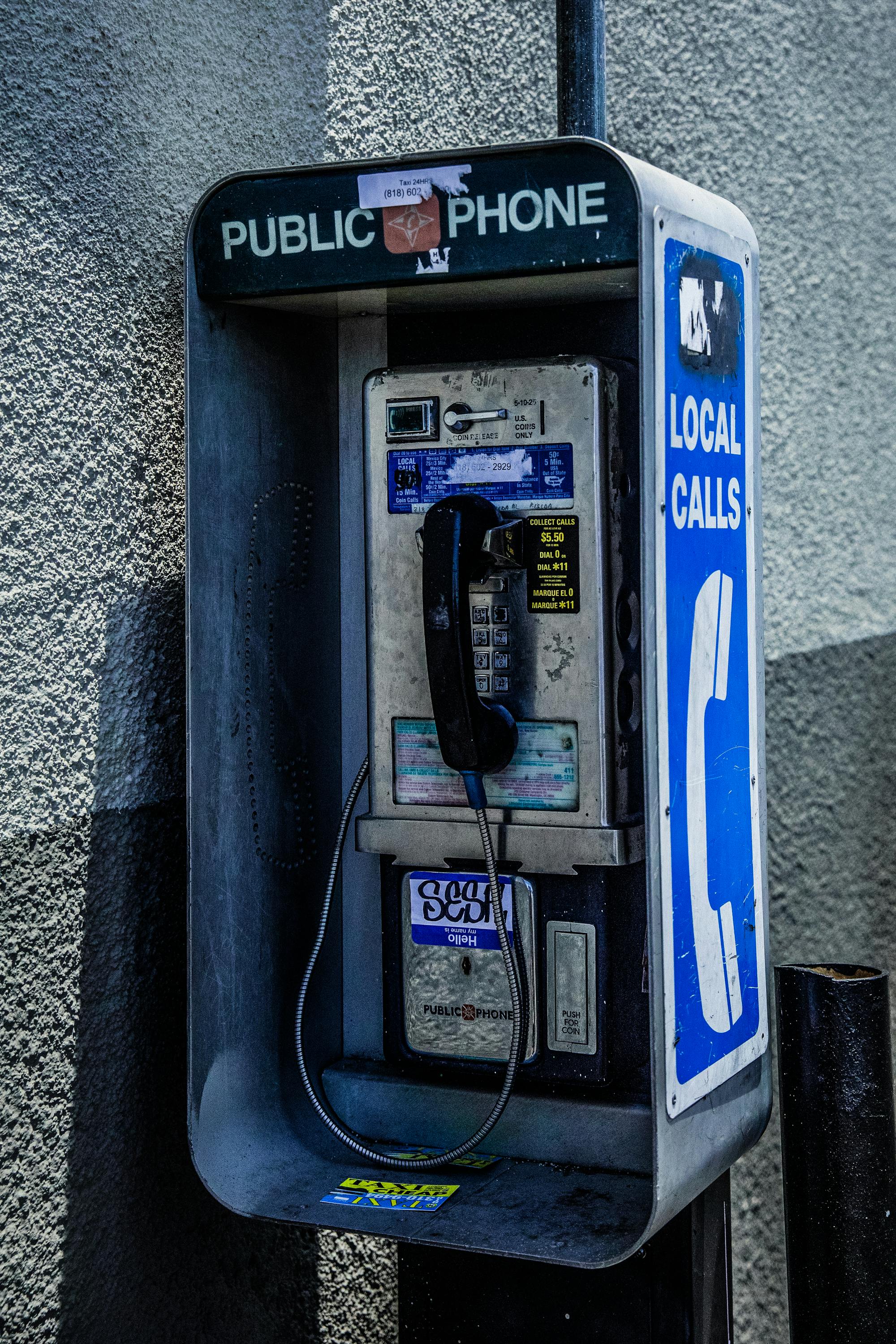 Public Telephone Booth on Street Sidewalk · Free Stock Photo
