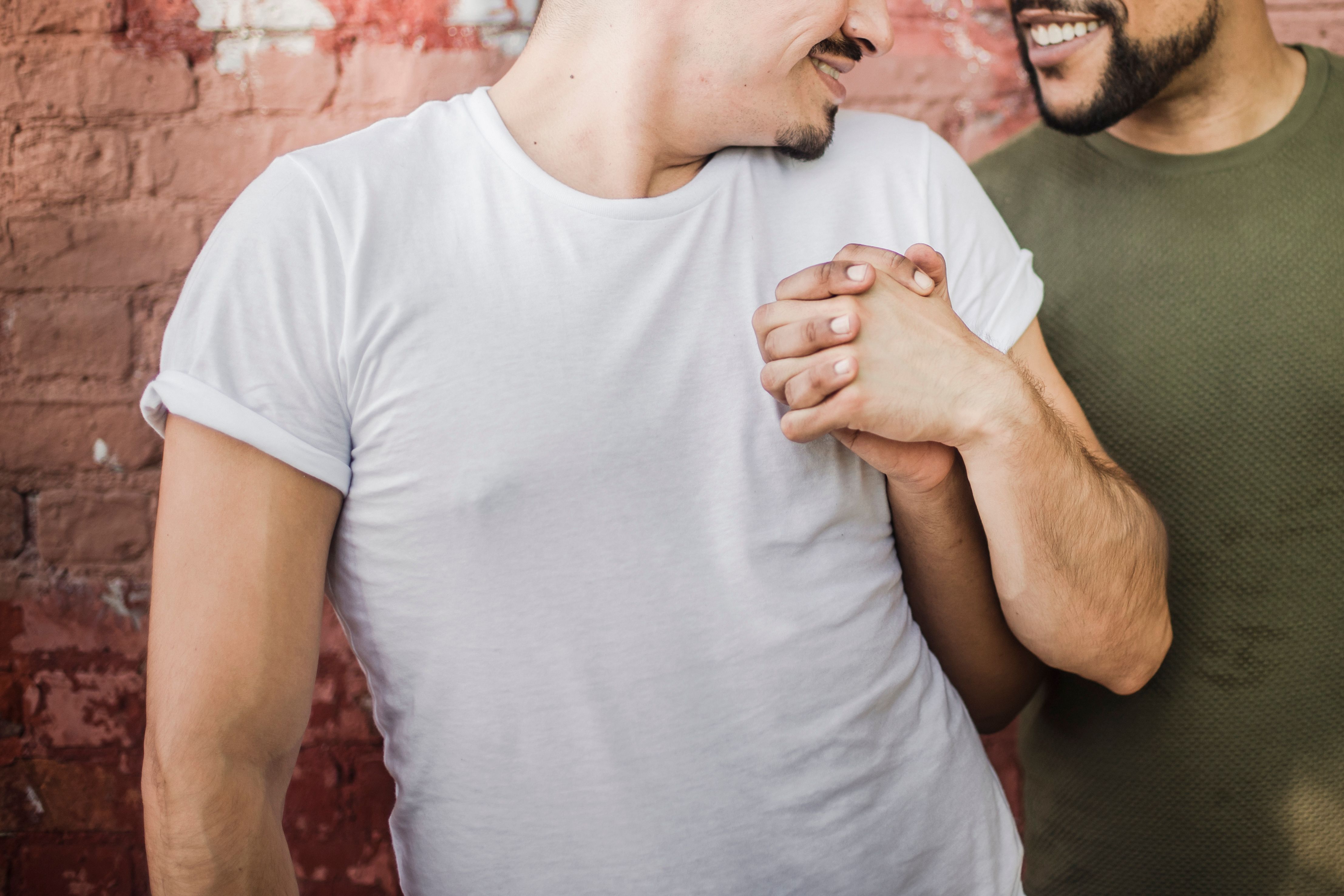 Close Up Photo of Men Holding Hands · Free Stock Photo