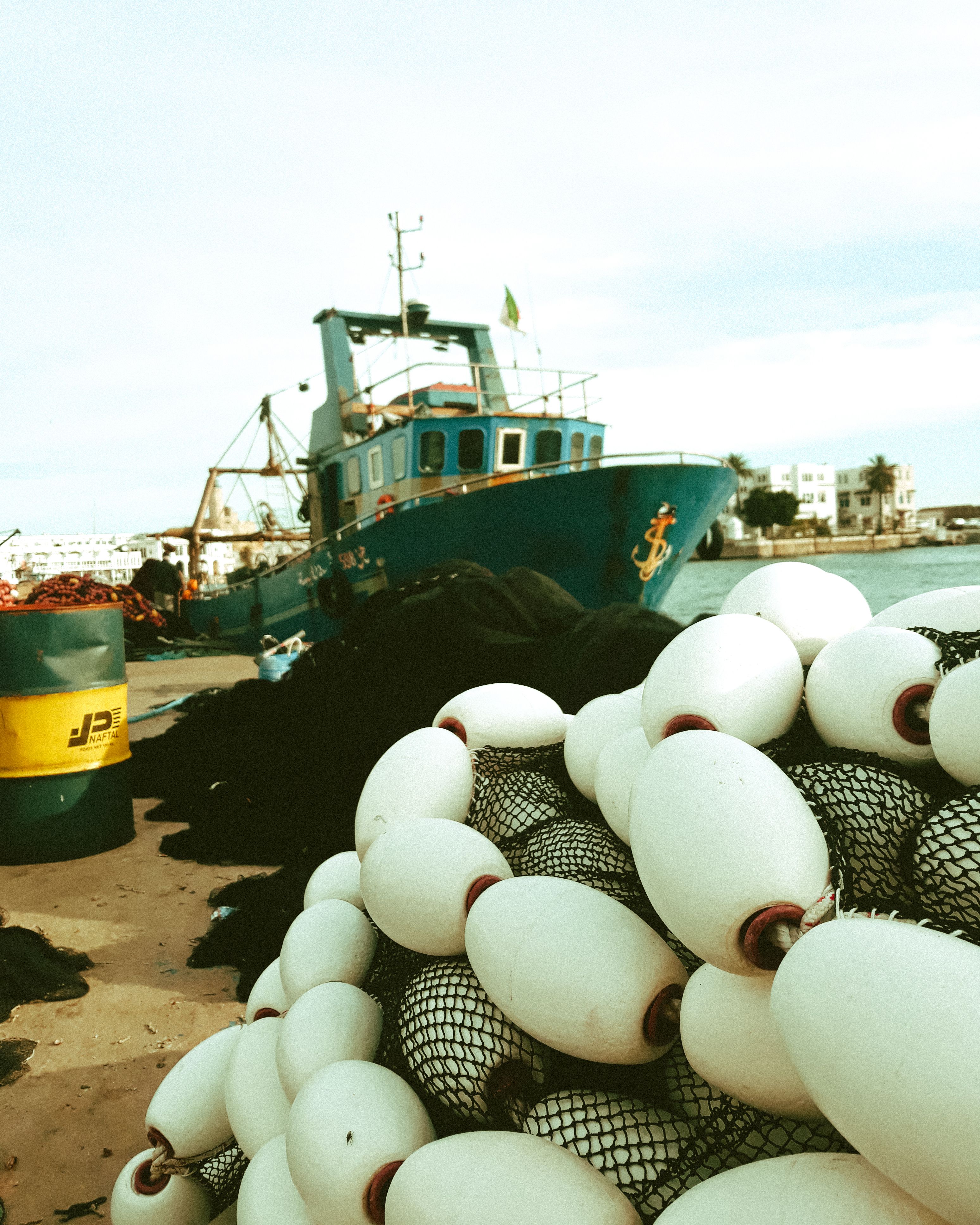 Fishing Nets and Ship in Harbor · Free Stock Photo