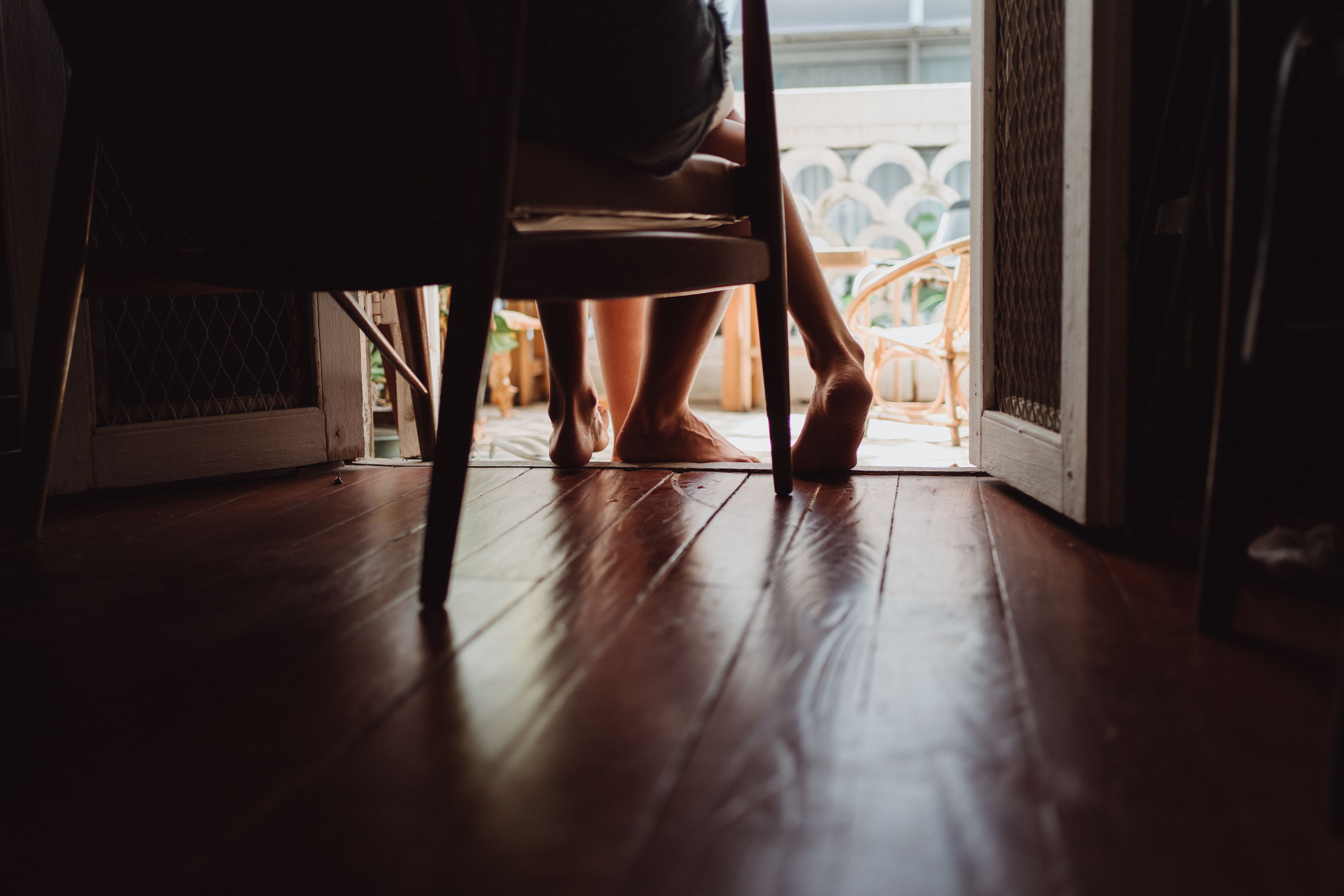 Legs of People Sitting in Chair by Balcony · Free Stock Photo