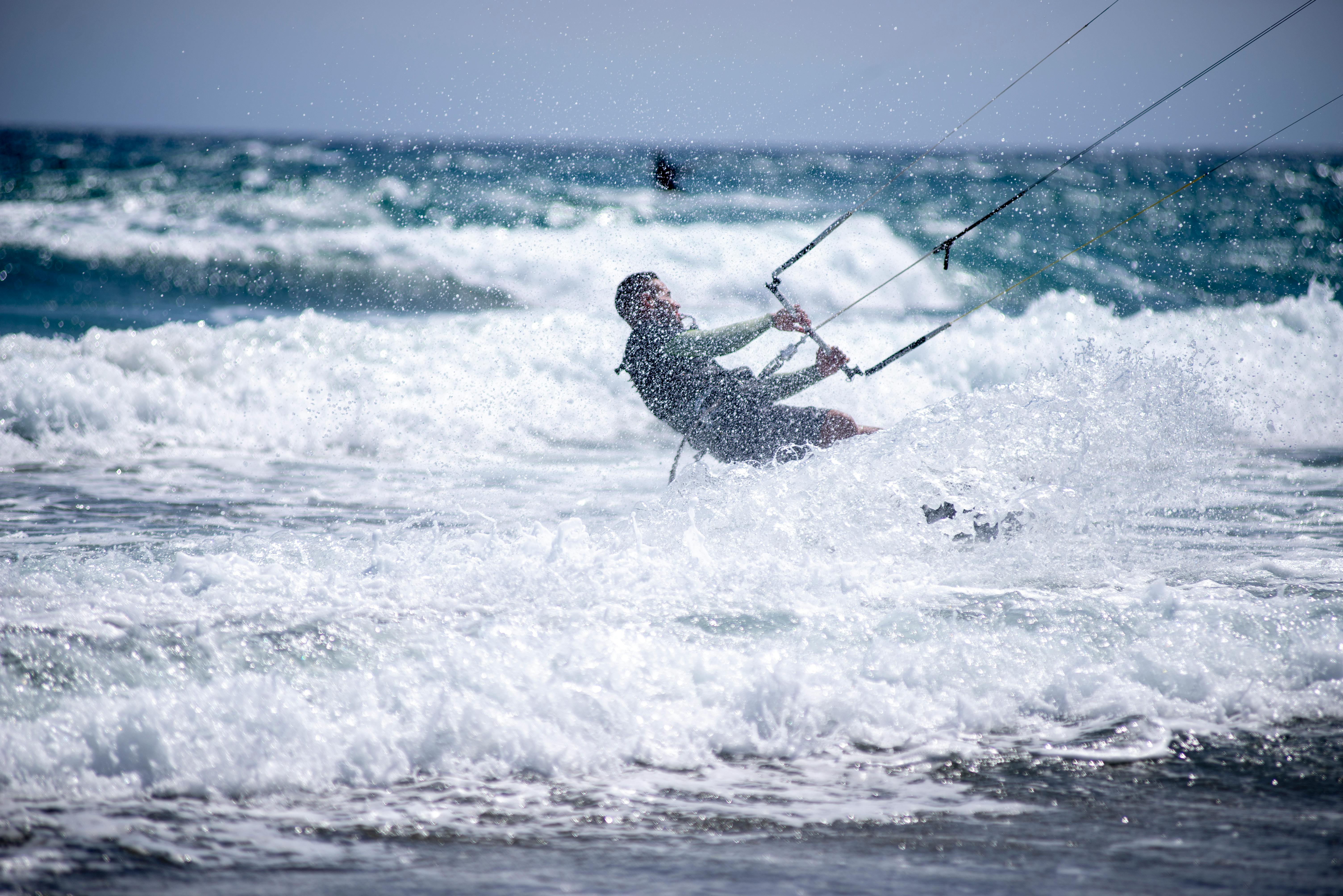 Man Parasailing While Wearing Wetsuit · Free Stock Photo
