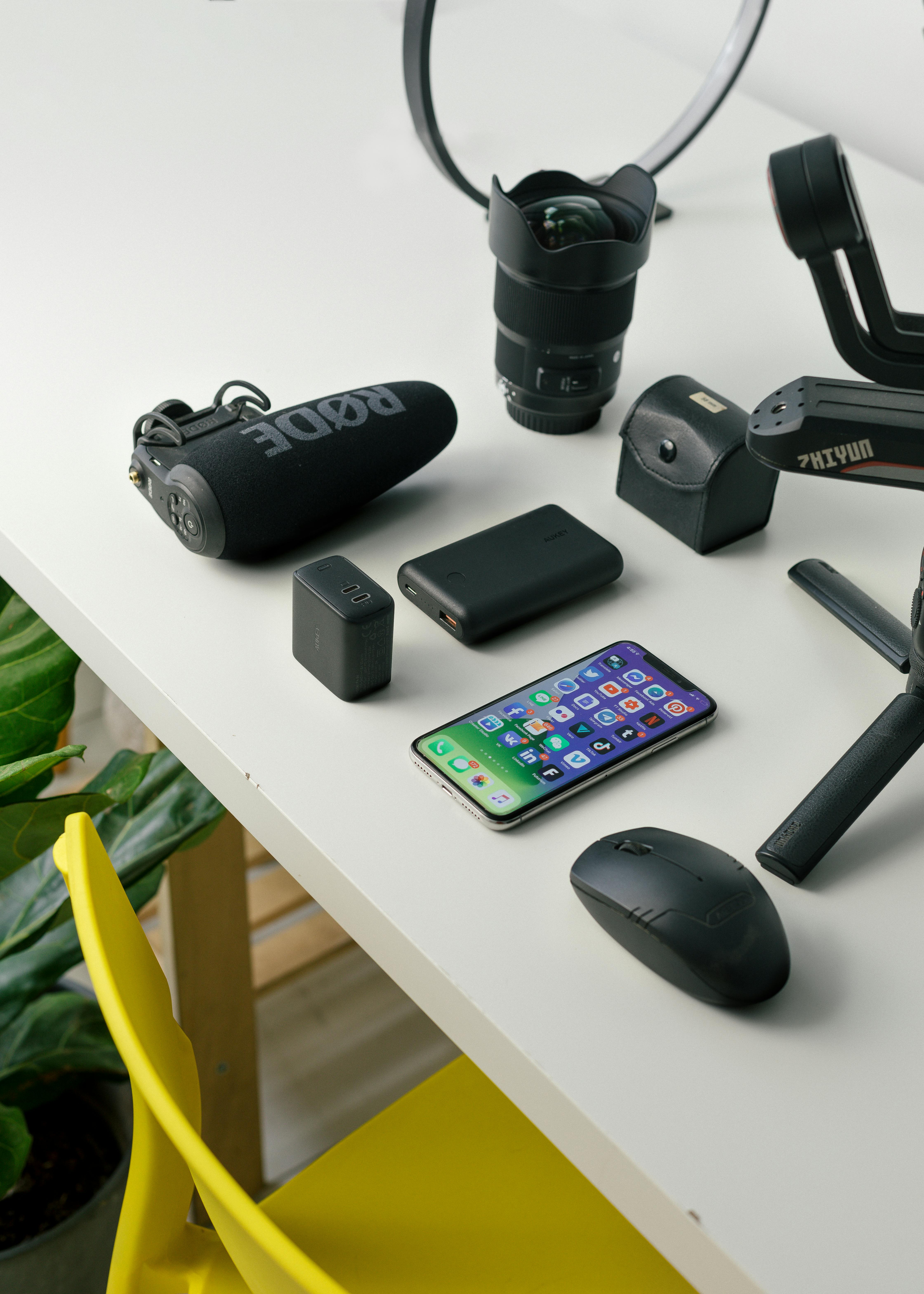 A Mobile Phone and Various Camera Equipment on a Table · Free Stock Photo