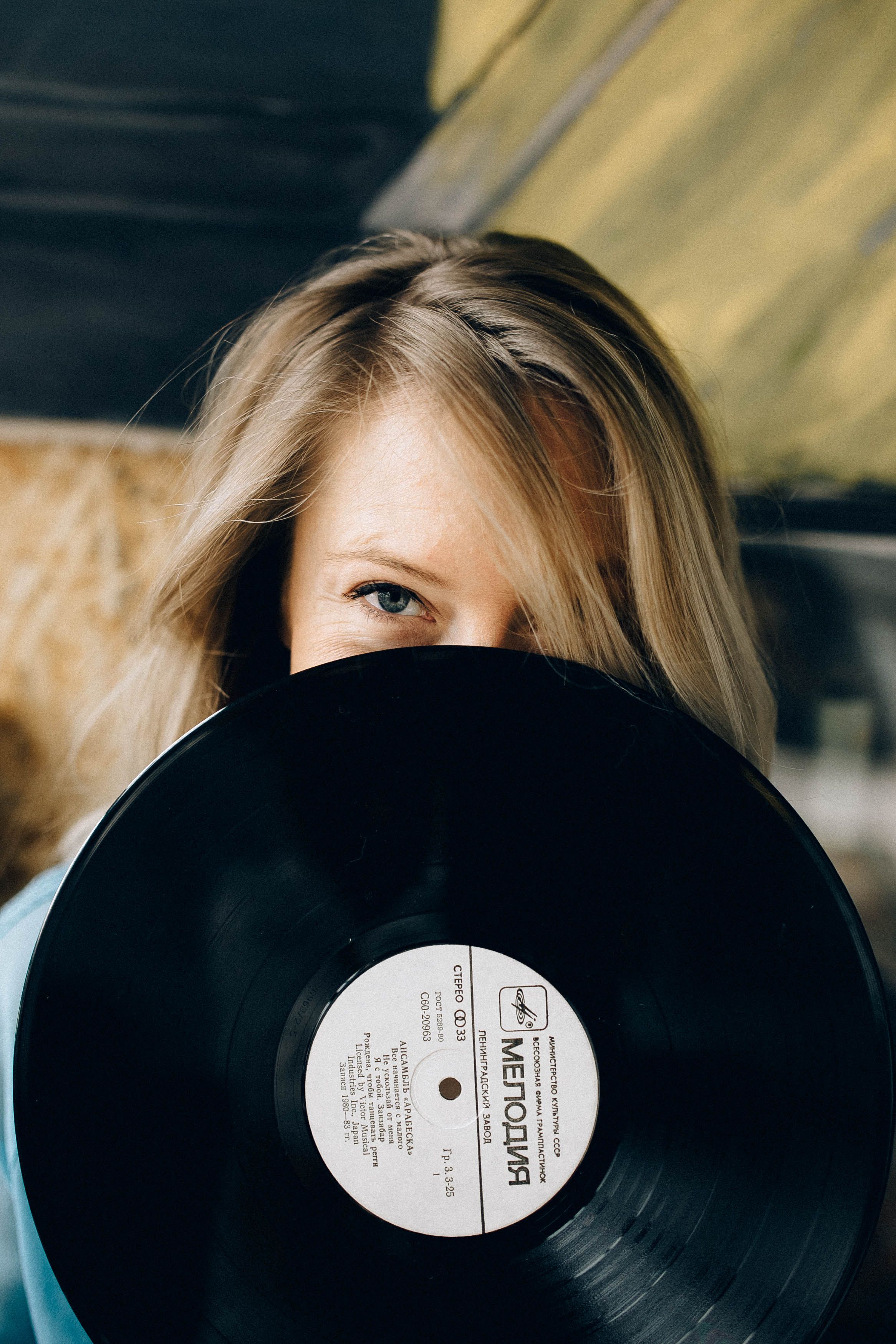 A Woman Holding a Vinyl Record · Free Stock Photo