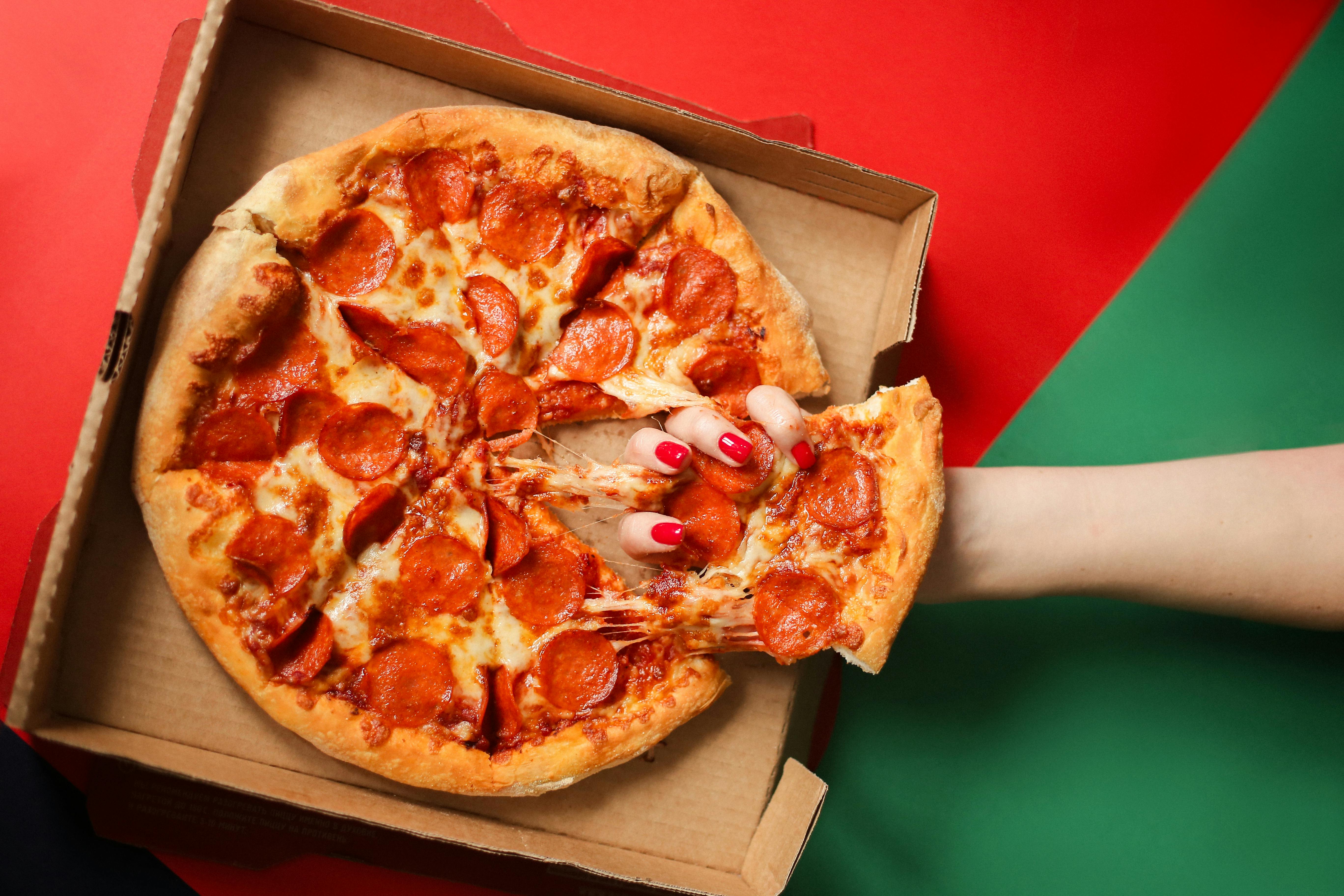 People Sharing a Pizza · Free Stock Photo