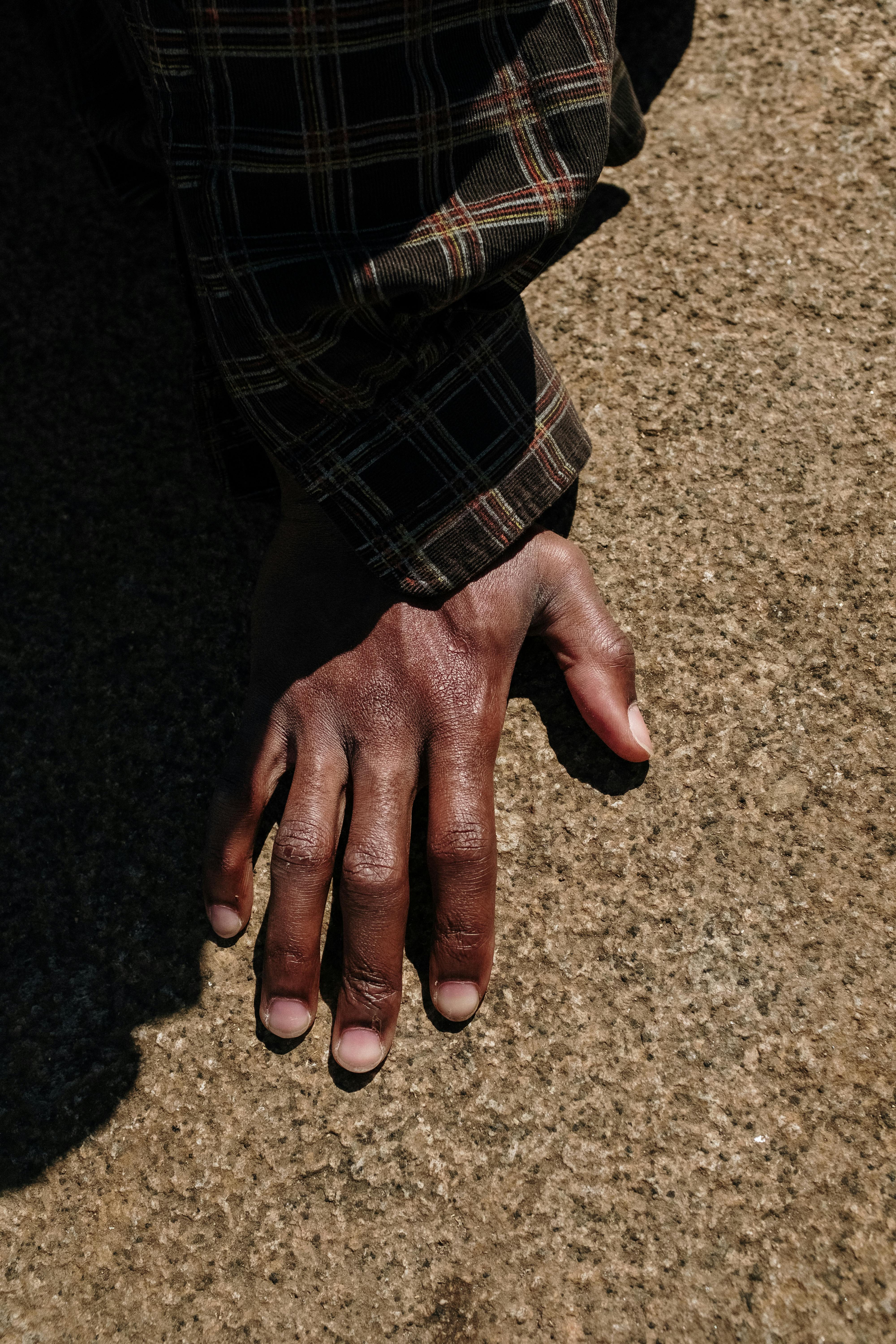 Hand on Concrete Surface · Free Stock Photo