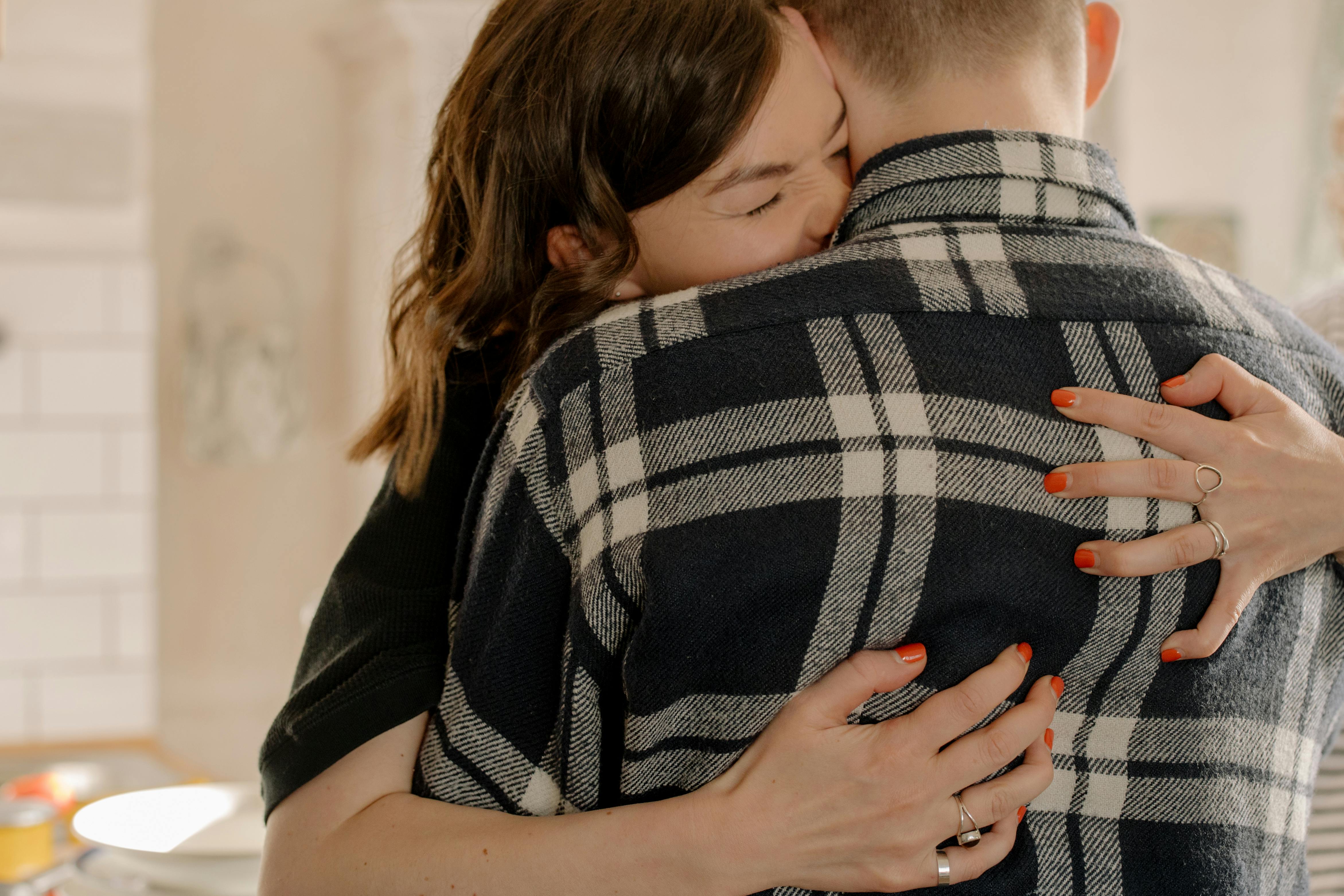 Man in Black and White Checkered Shirt Hugging Woman in Black and White ...
