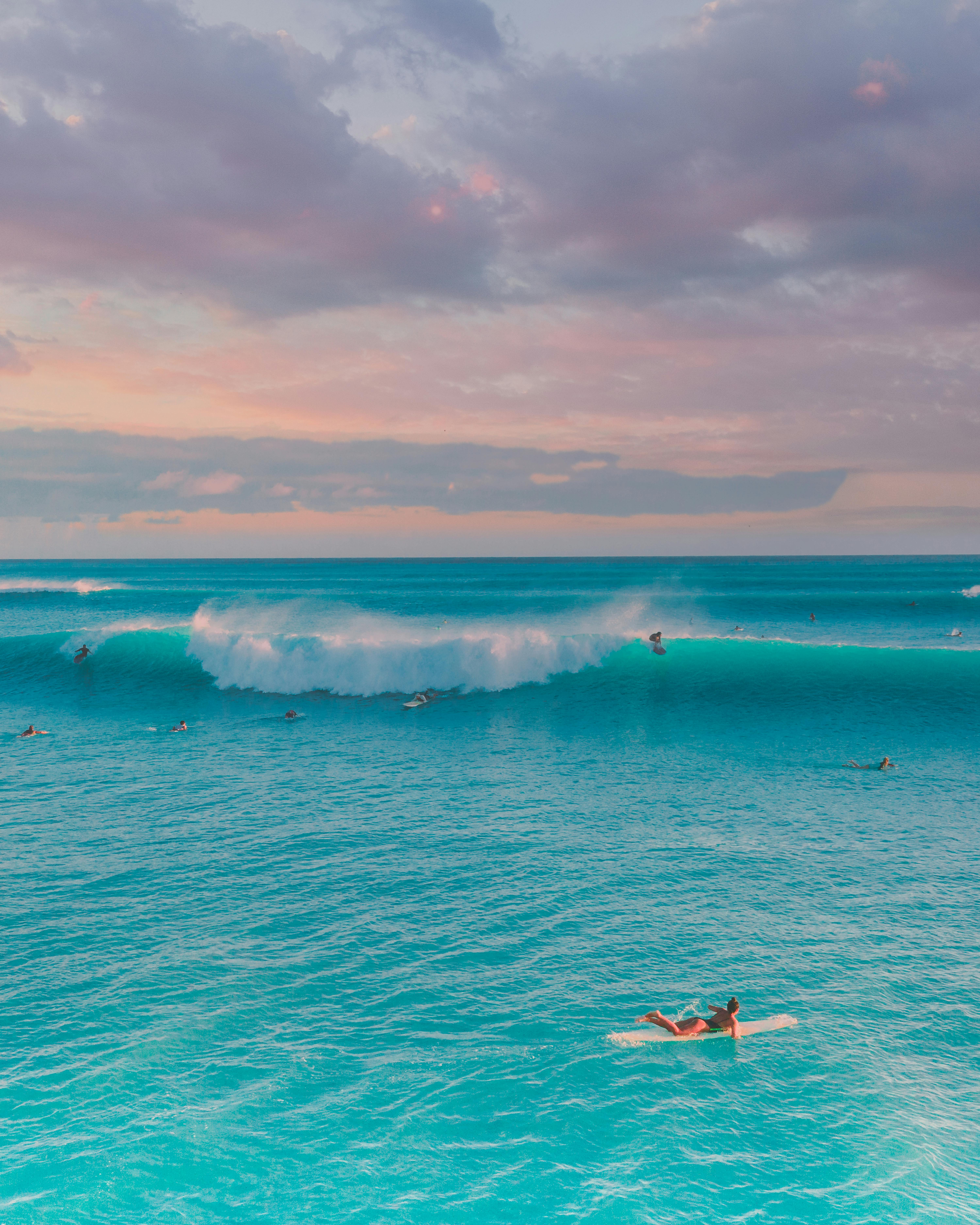 People Surfing on Blue Sea · Free Stock Photo