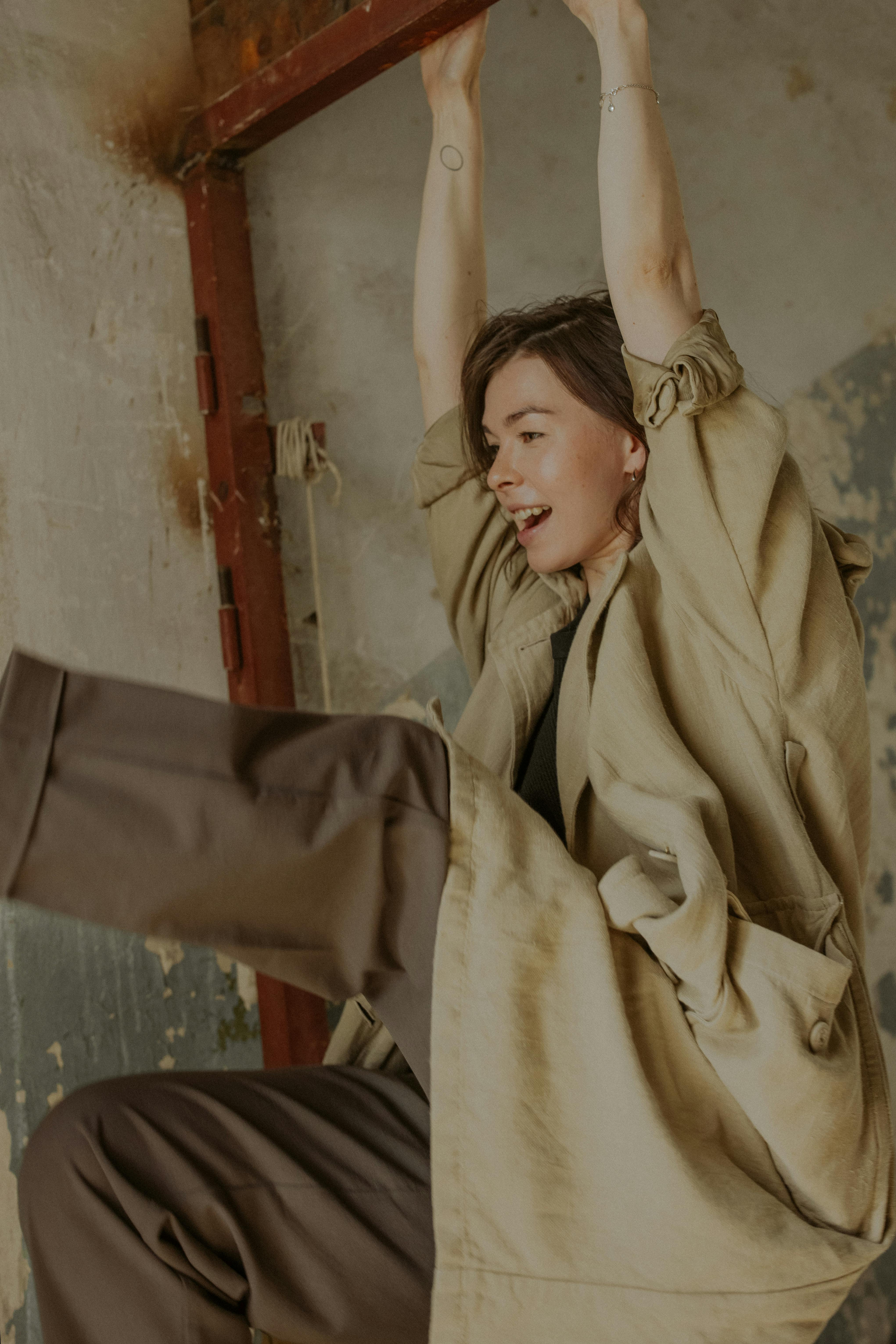 Woman in Brown Coat Sitting on Chair · Free Stock Photo