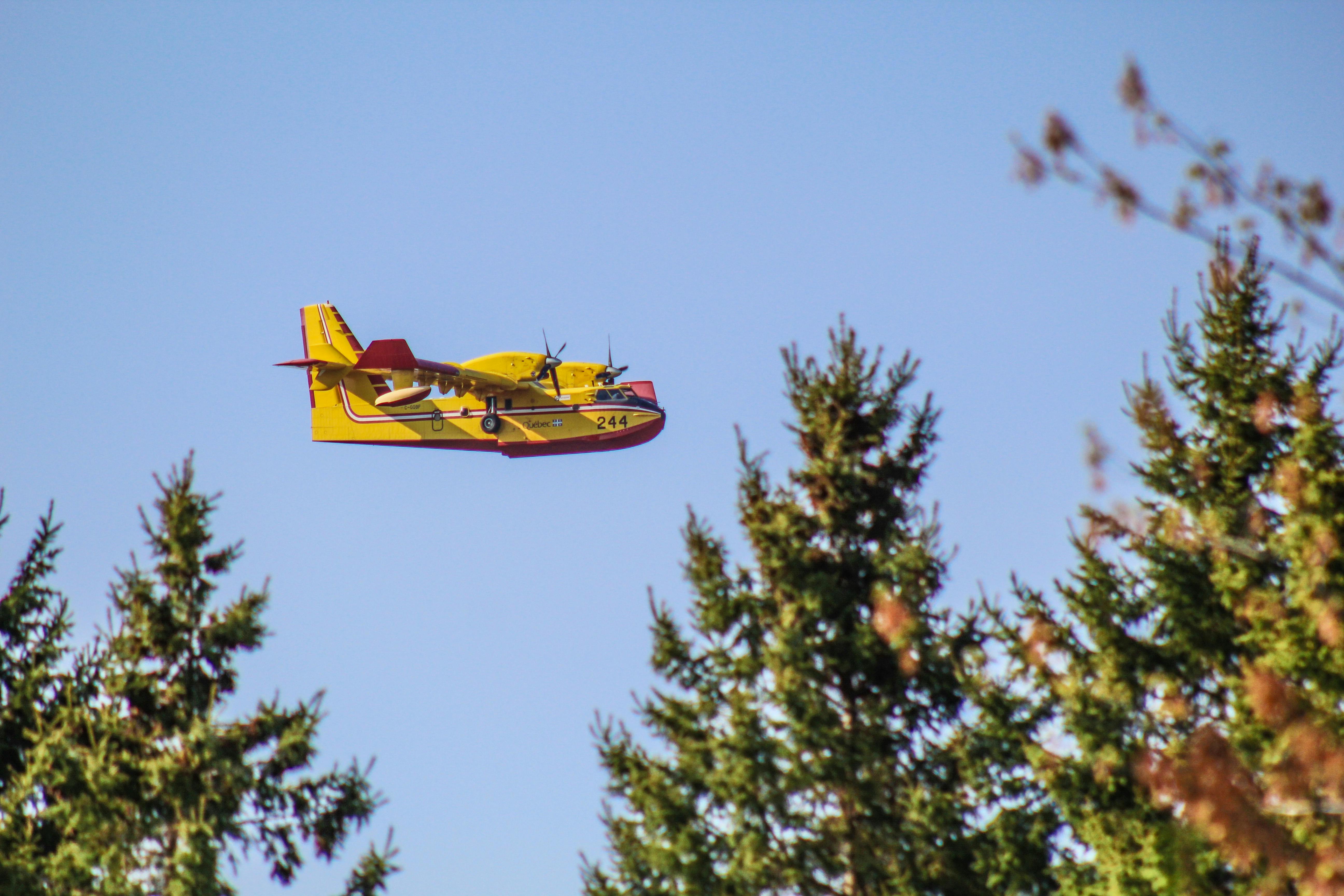 A Yellow Aircraft Flying in the Sky · Free Stock Photo