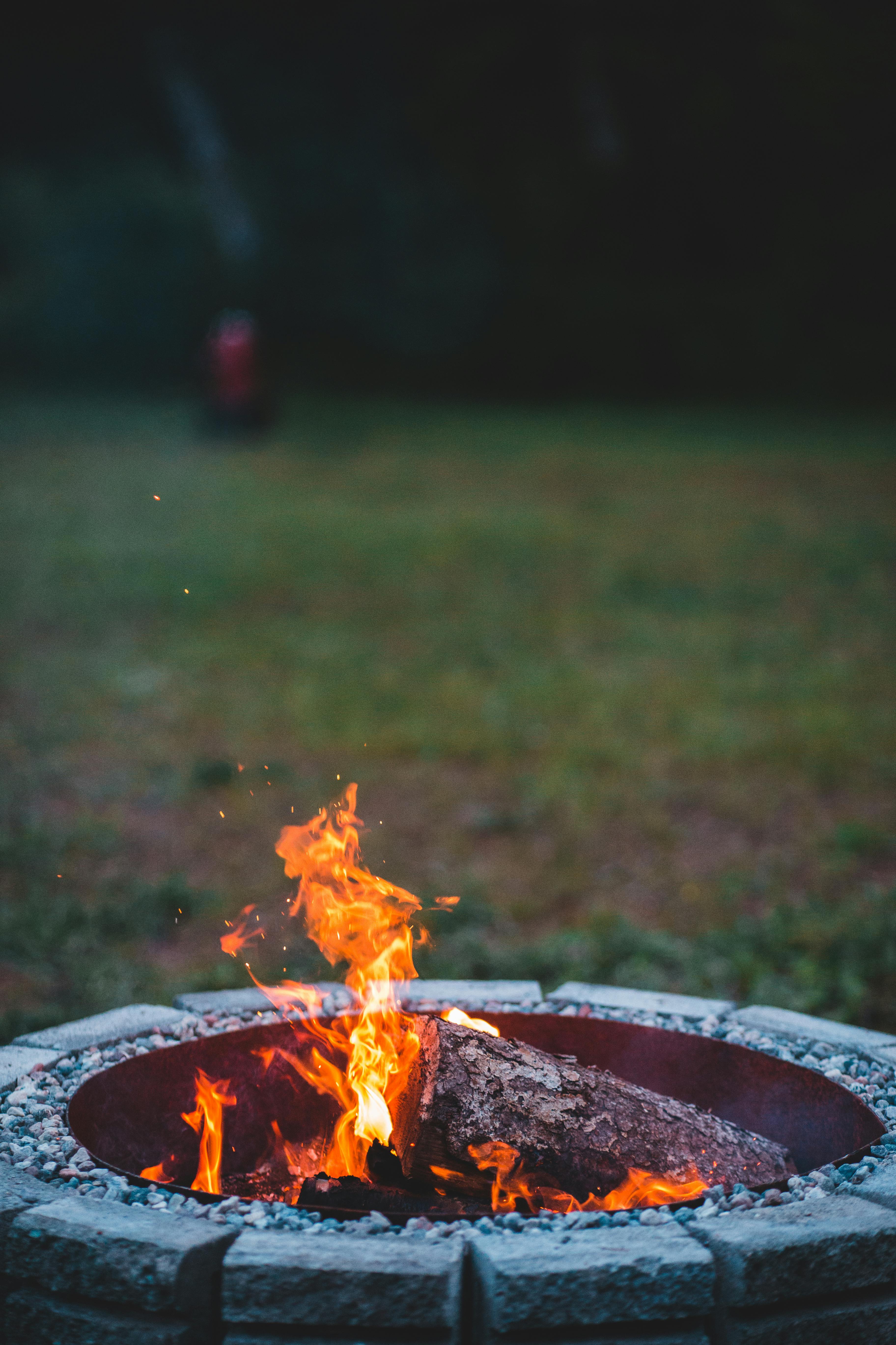 Flaming bonfire in round bowl in park · Free Stock Photo